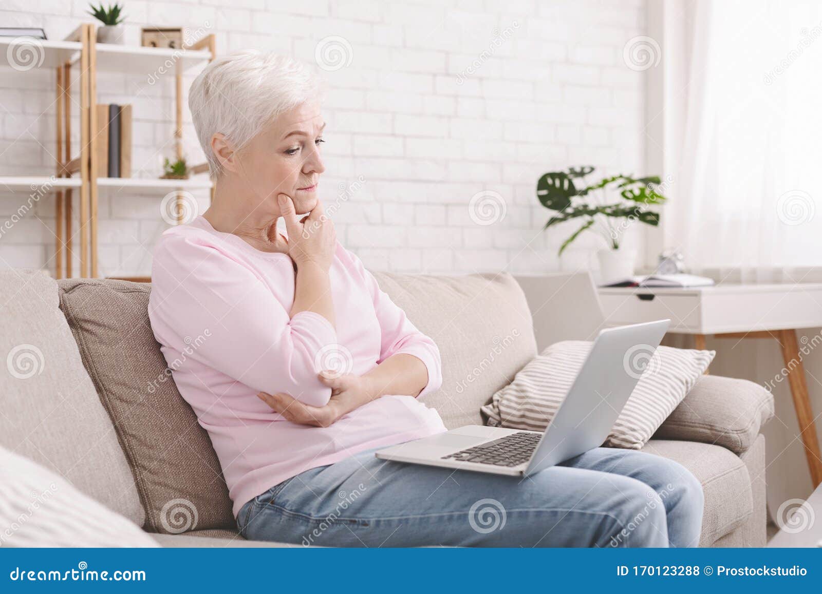 Puzzled Senior Lady Looking at Laptop with Perplexity Stock Photo ...