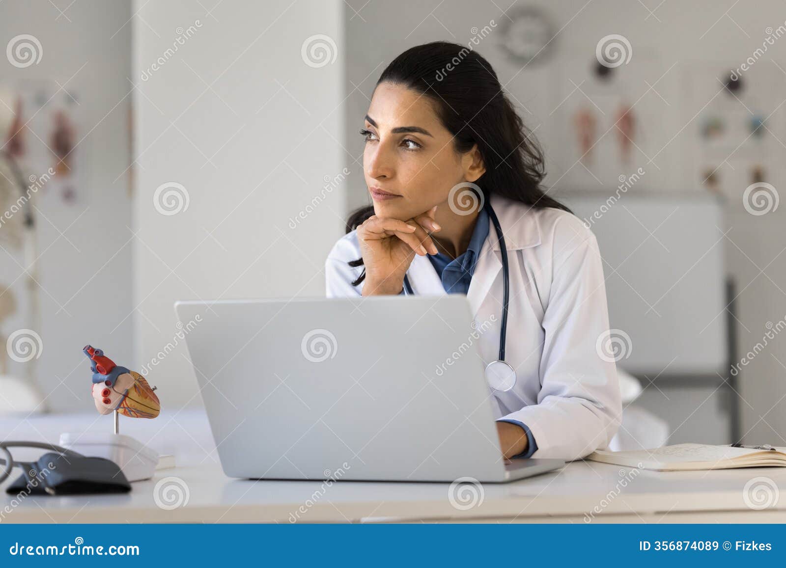 Pensive Young Female Doctor Look Aside of Notebook Screen Stock Image ...