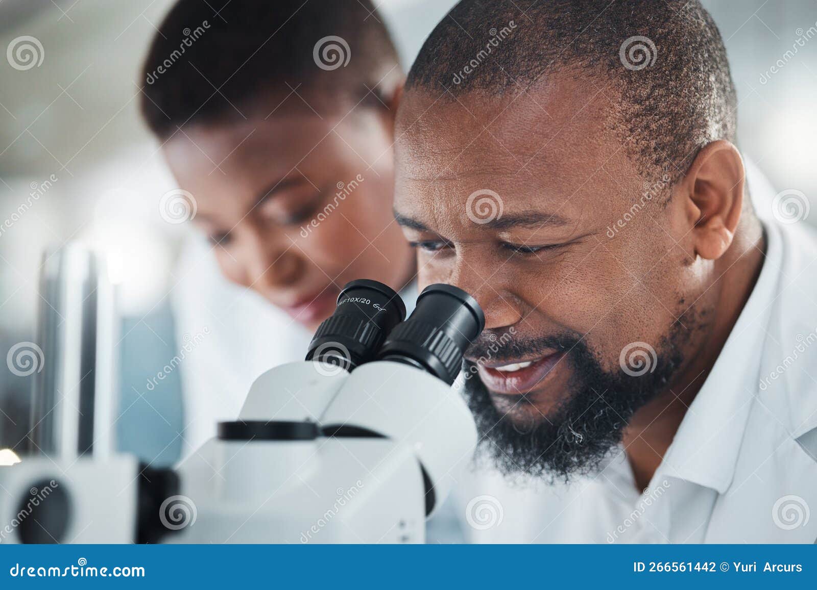 Problem Solving is What they Do Best. a Mature Man Using a Microscope ...