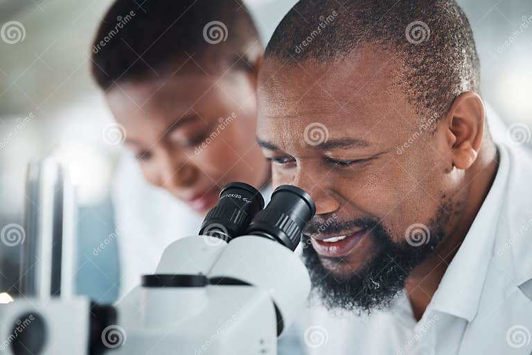 Problem Solving is What they Do Best. a Mature Man Using a Microscope ...