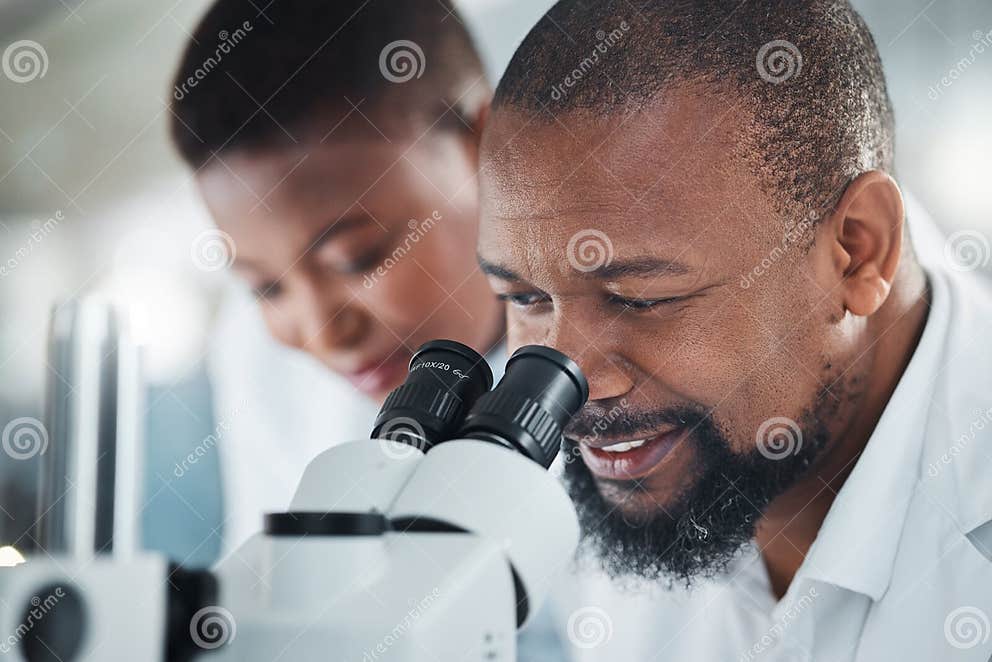 Problem Solving is What they Do Best. a Mature Man Using a Microscope ...