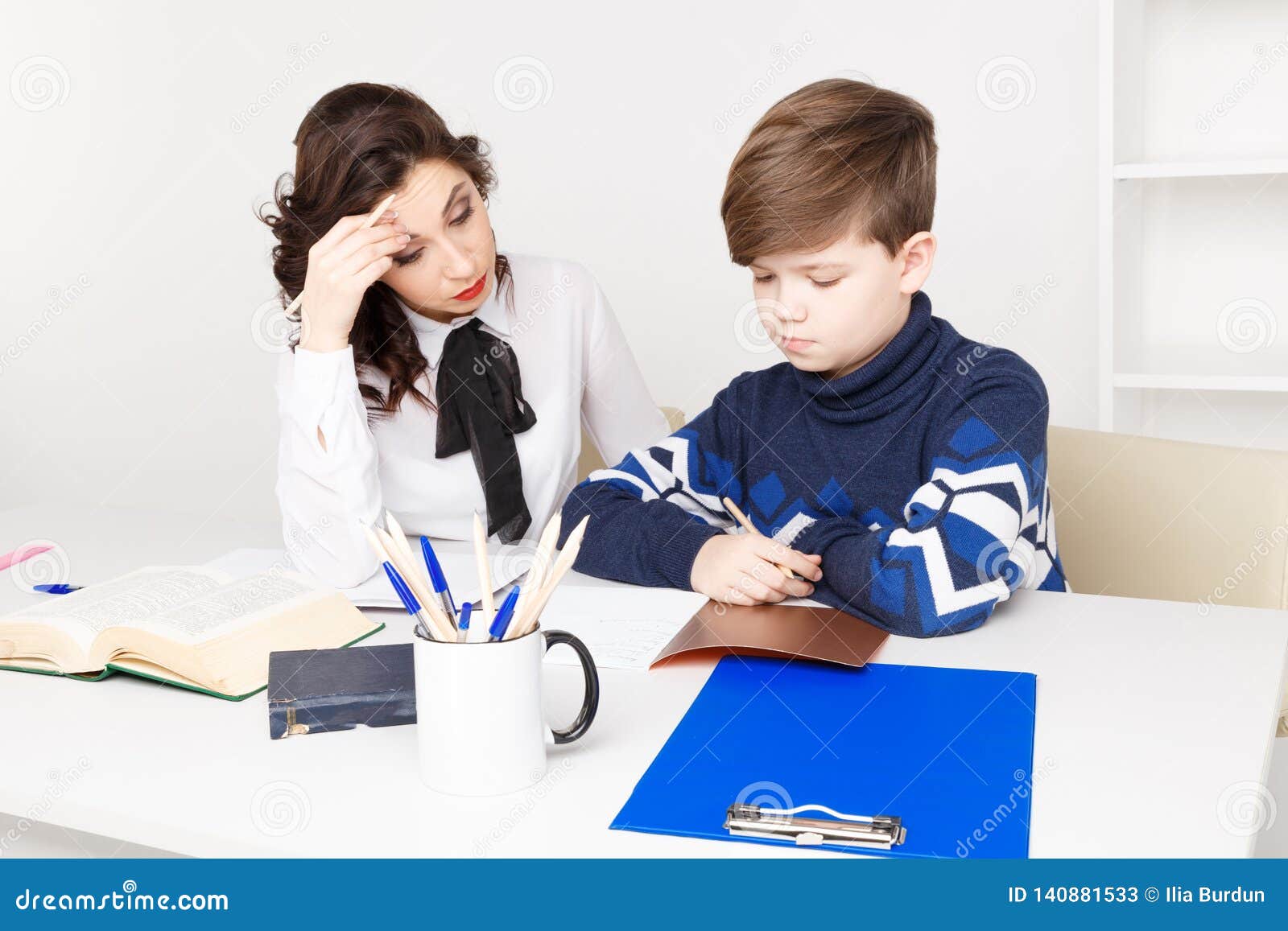 Proccess of Doing Homework by the Boy with His Teacher. Stock Image ...