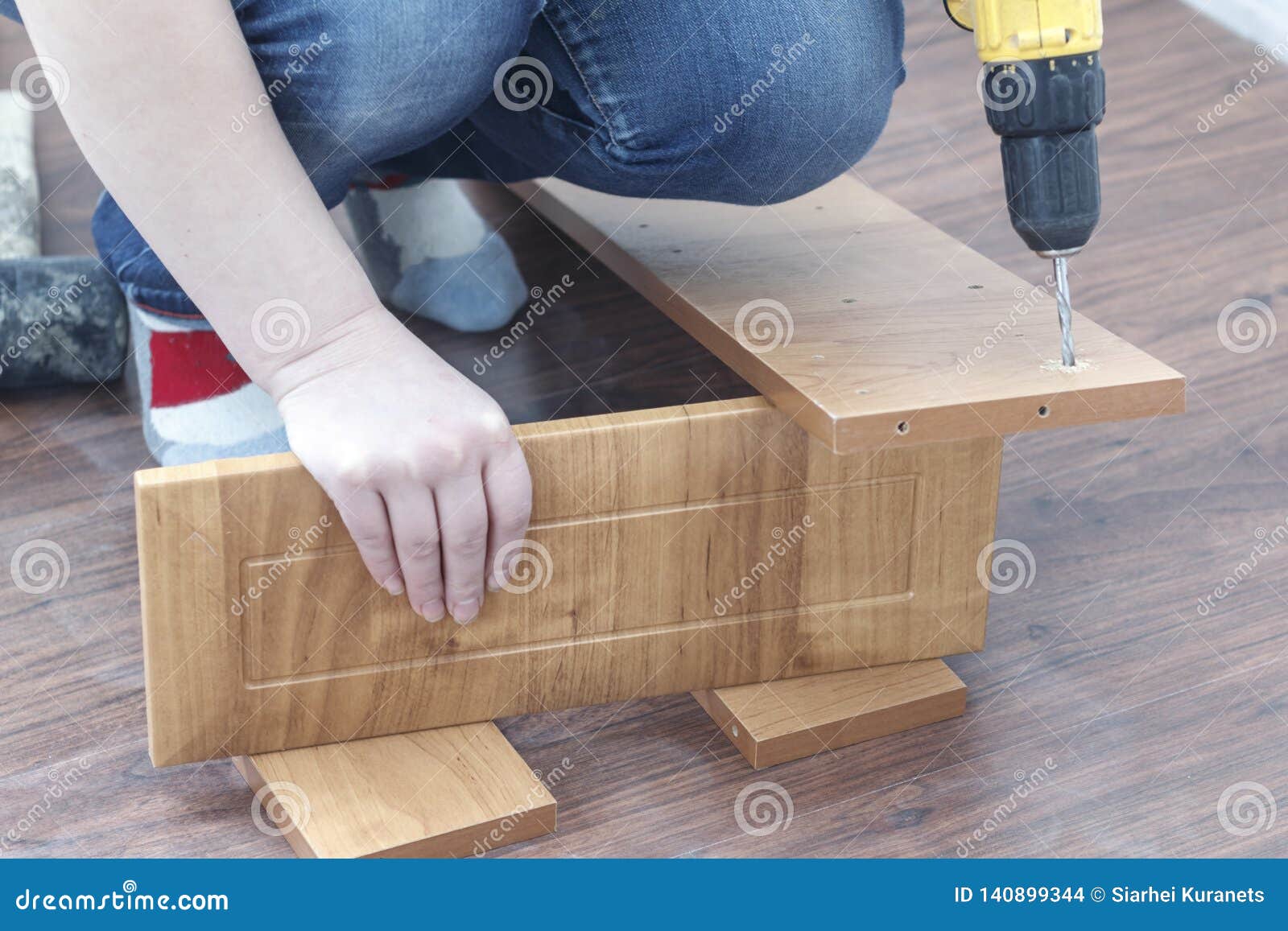 Is The Process Of Assembling Furniture From Chipboard In The Hands