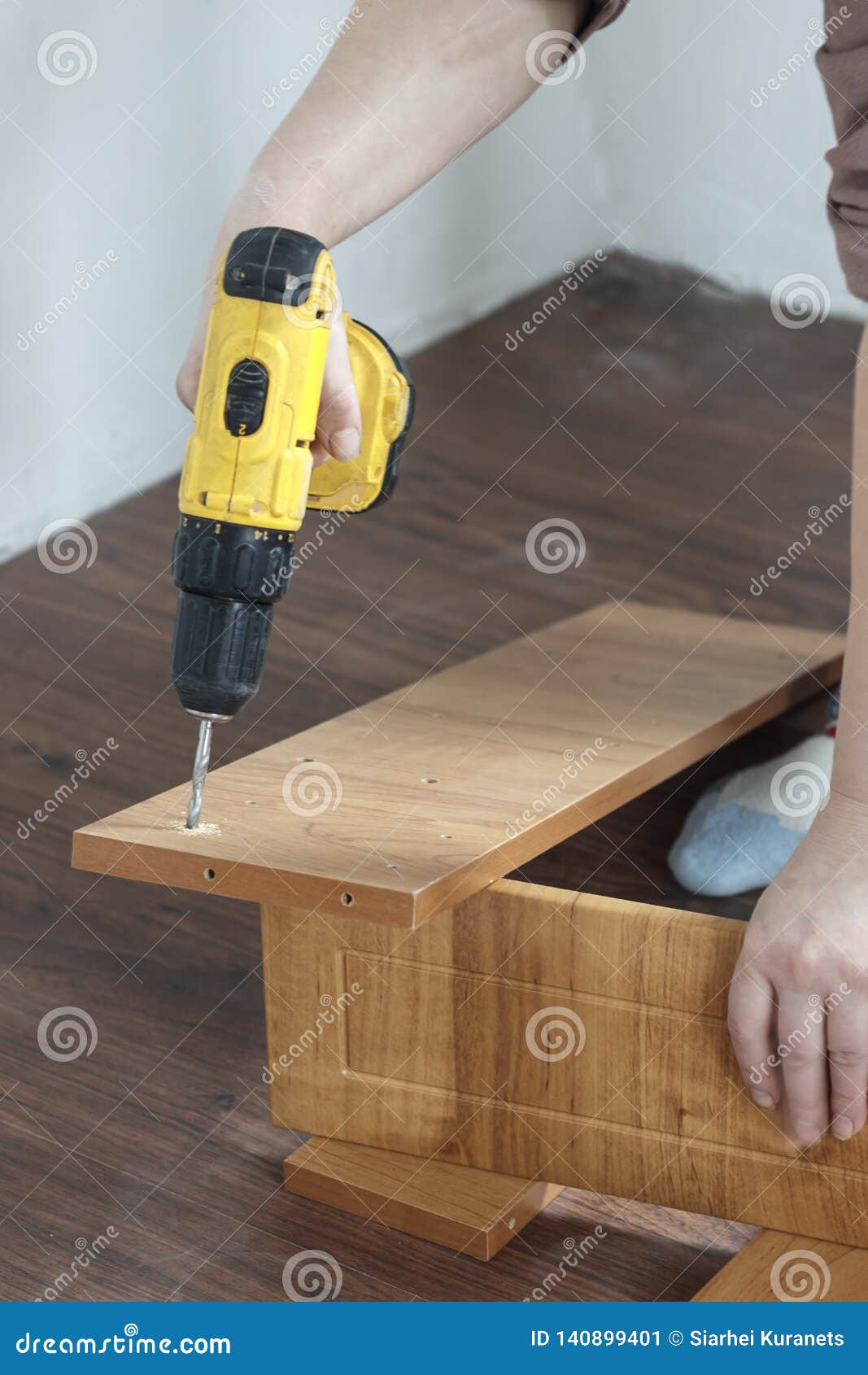 Is The Process Of Assembling Furniture From Chipboard In The Hands