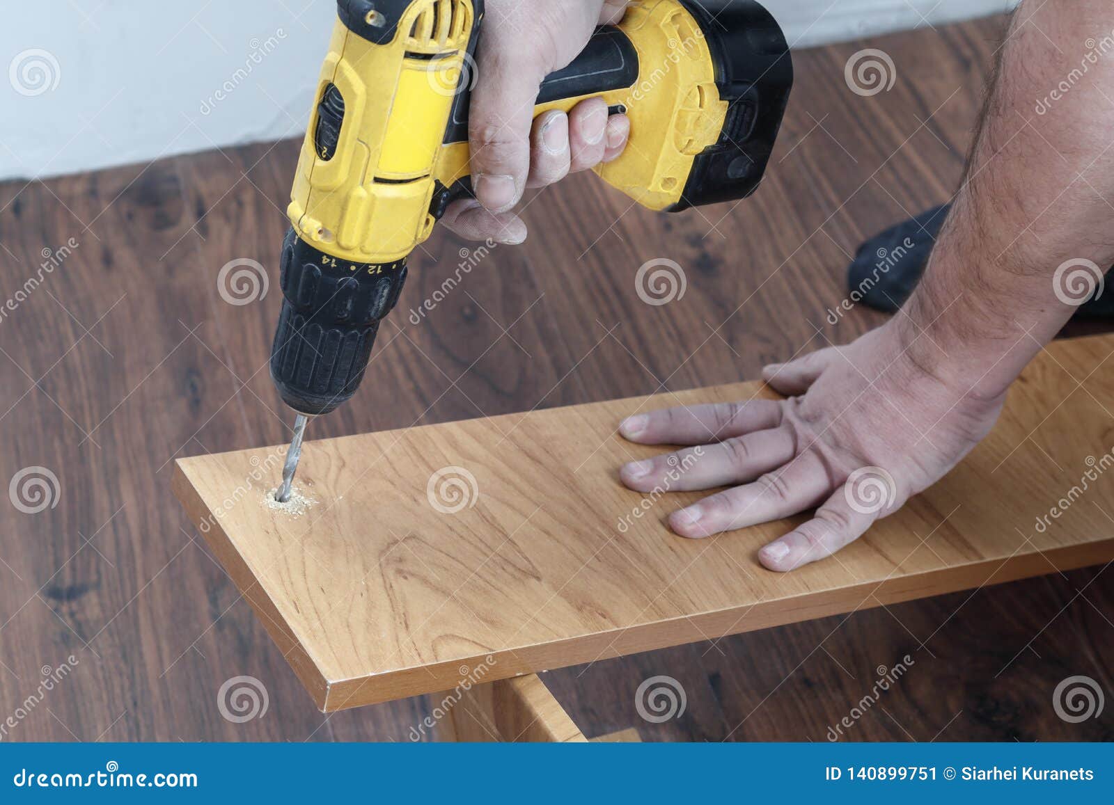 Is The Process Of Assembling Furniture From Chipboard In The Hands