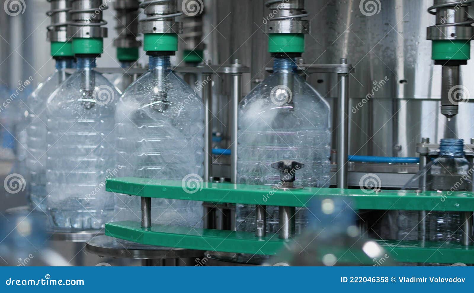 The Process of Automatic Filling of Water into a Plastic Bottle on the ...