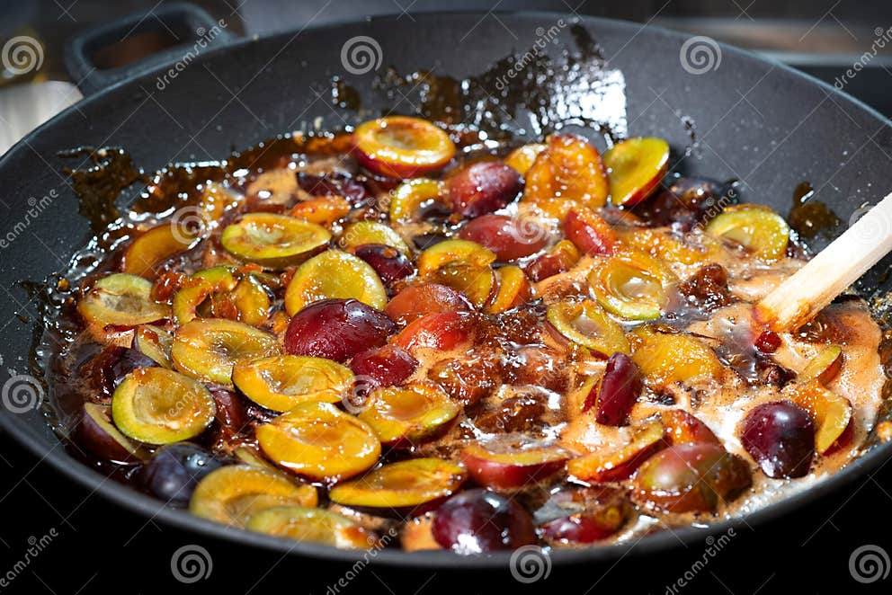 The Process of Boiling Plum Jam in a Cast Iron Pan Stock Photo - Image ...