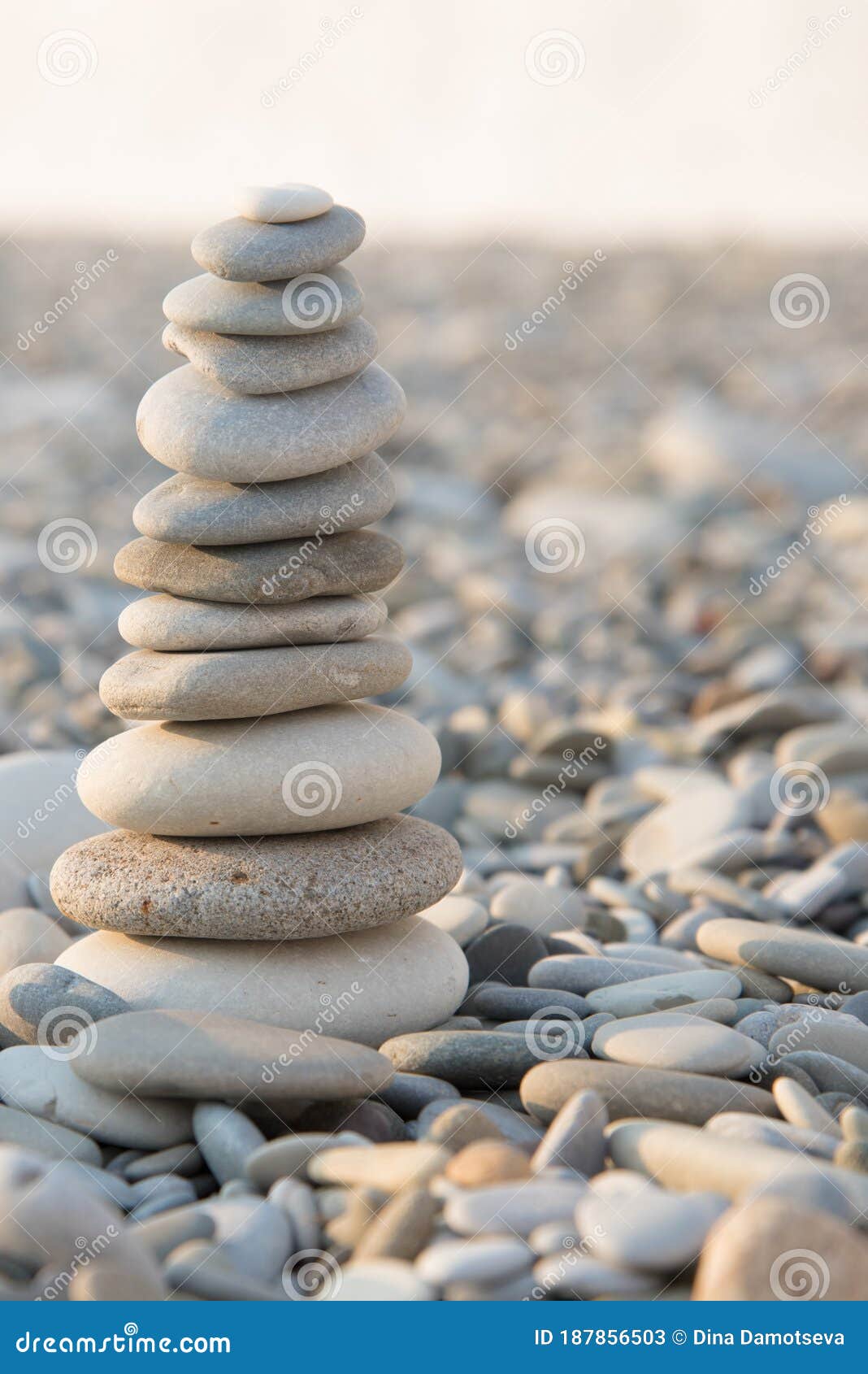 The Process of Building a Pyramid of Stones. a Close-up Hand Places the ...