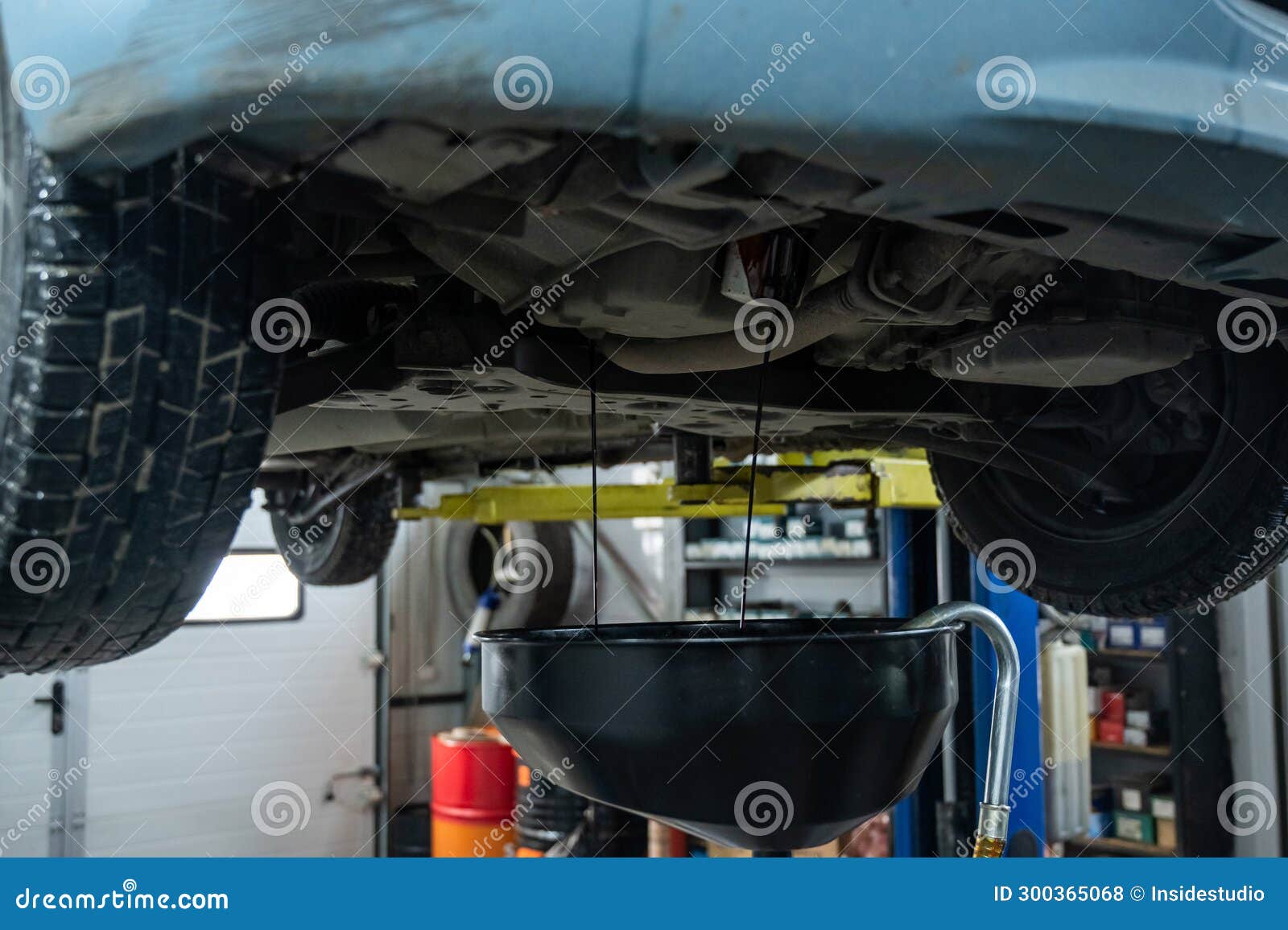 The Process of Changing the Oil in a Car Engine. Draining Old Dark Used ...