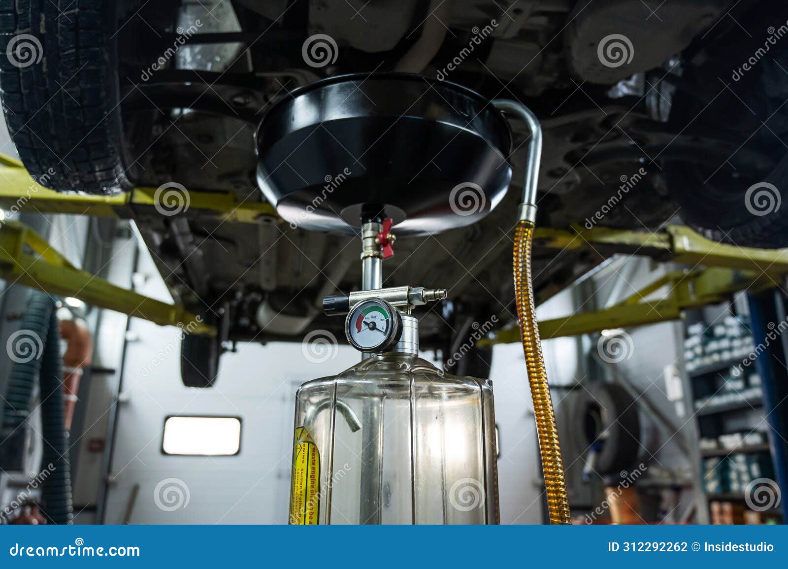 The Process of Changing the Oil in a Car Engine. Draining Old Dark Used ...