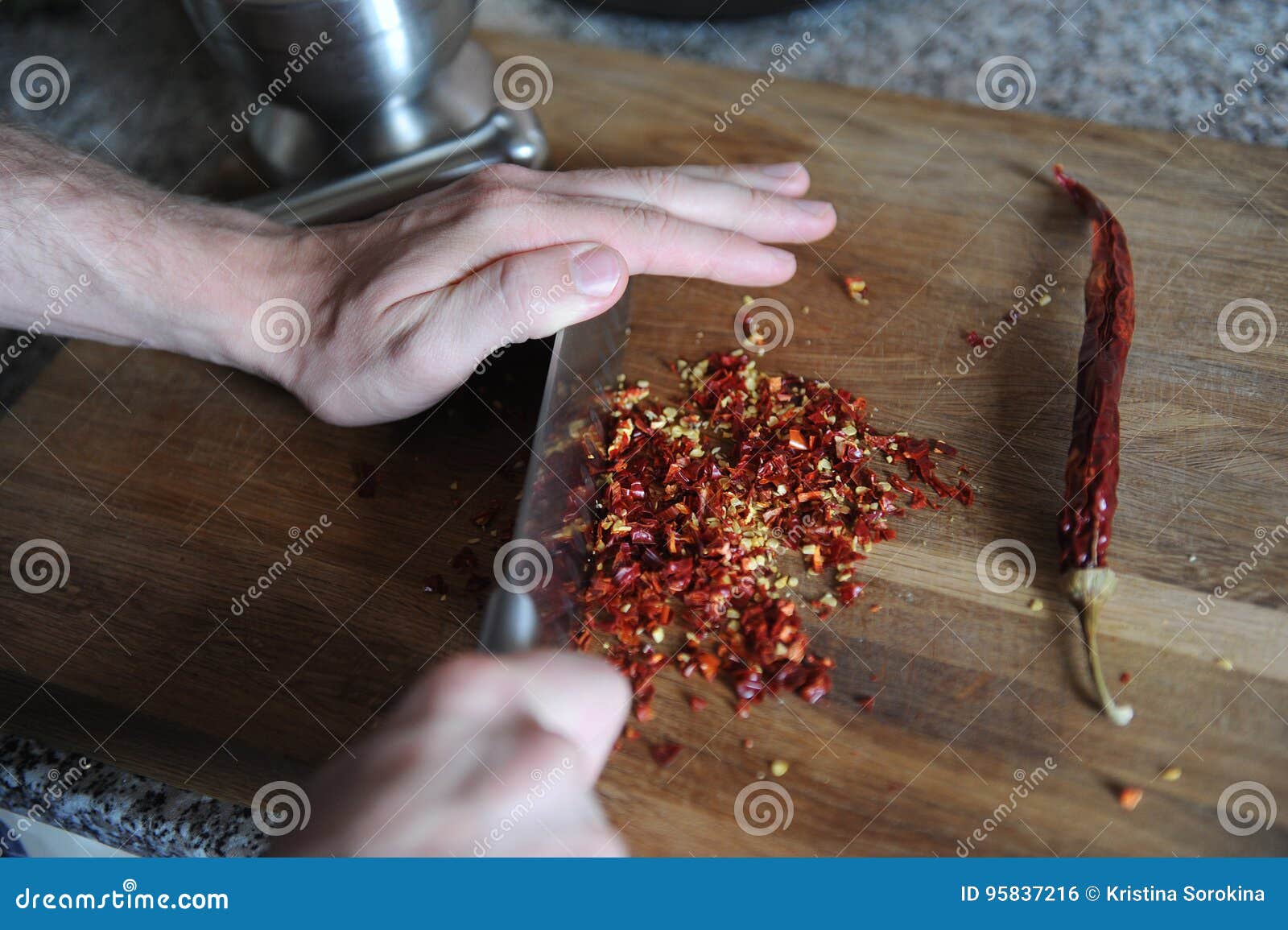 The Process Of Chopping Chili Pepper With Man`s Hands. Stump In The ...