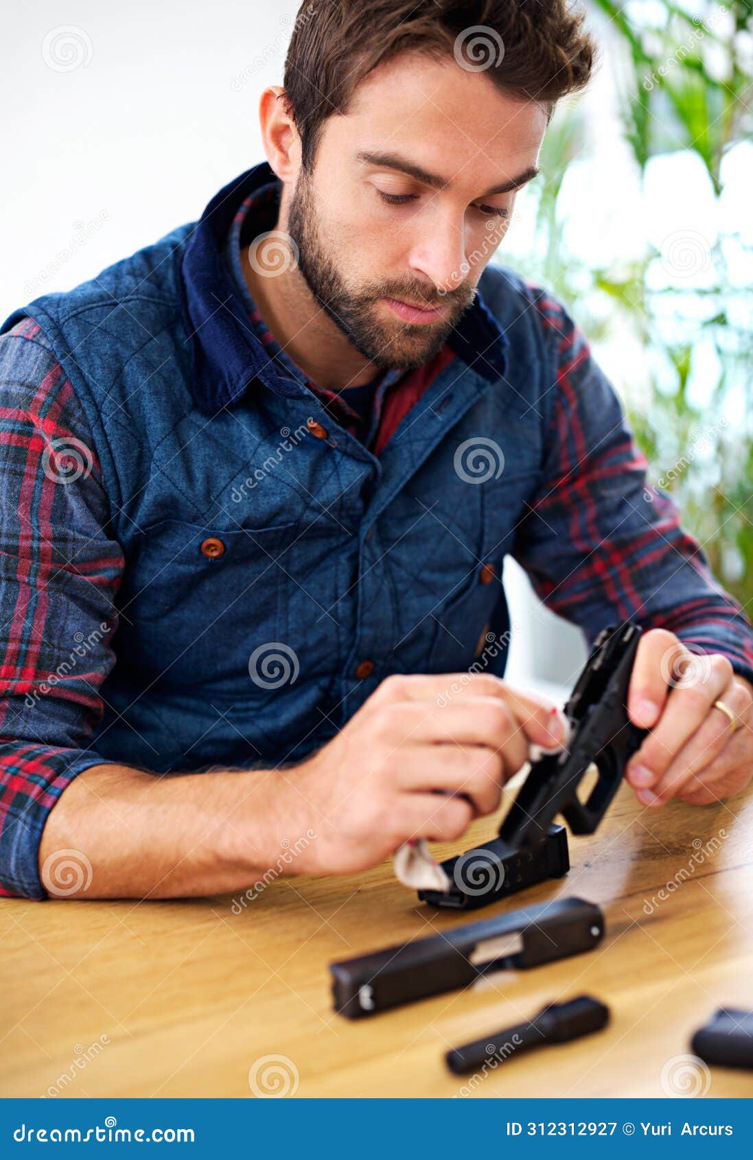 Process, Cleaning and Man with Gun at Table for Safety, Self Defense ...