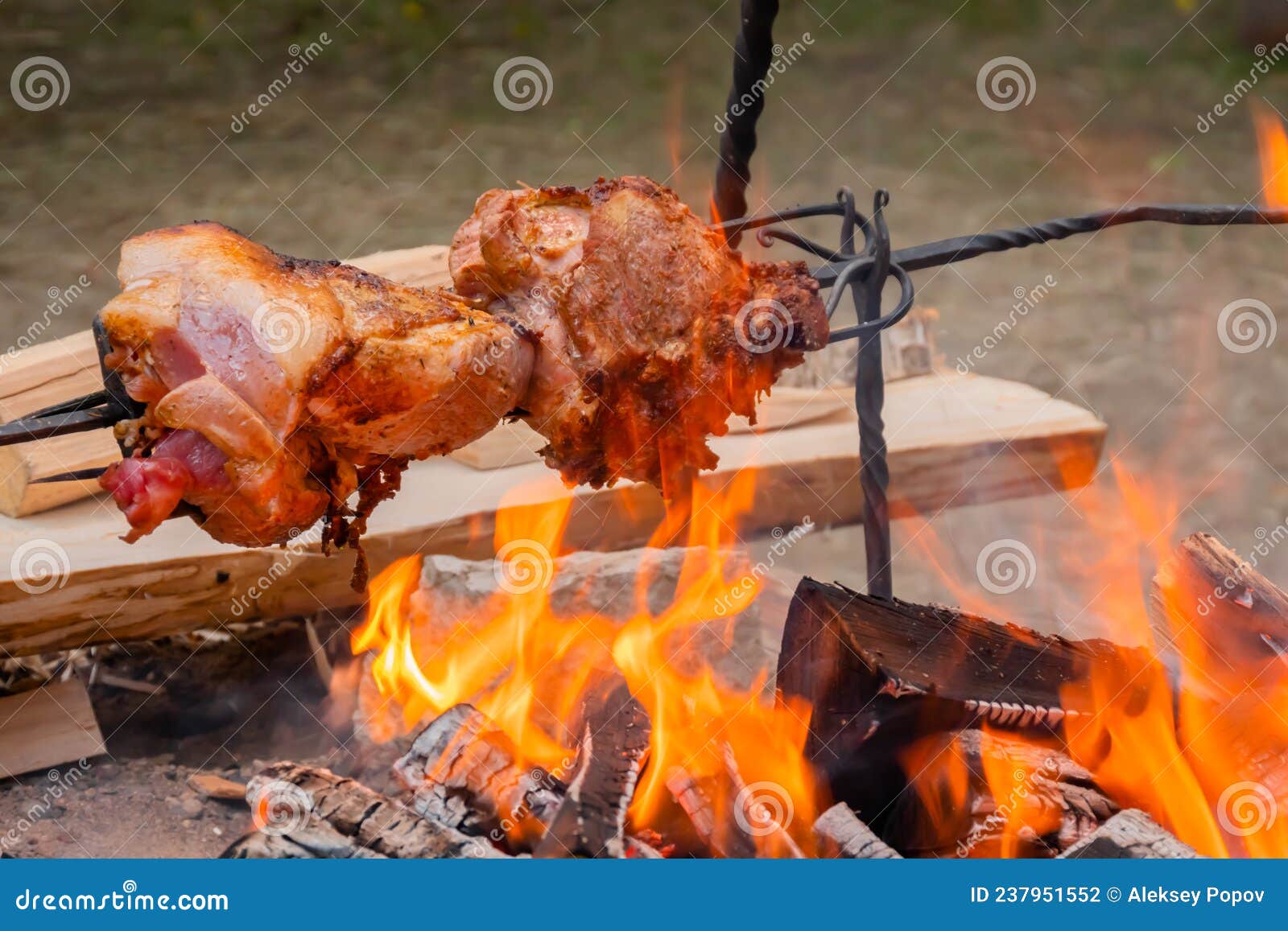 Process of Cooking Large Meat Peaces on Spit Over Open Fire Stock Photo ...