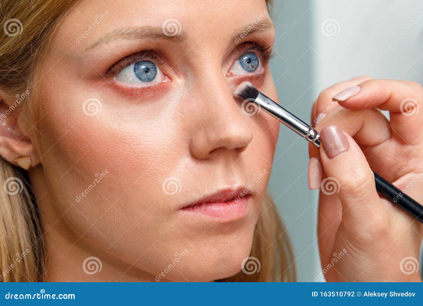 The Process of Creating Makeup. Makeup Artist Working with a Brush on ...