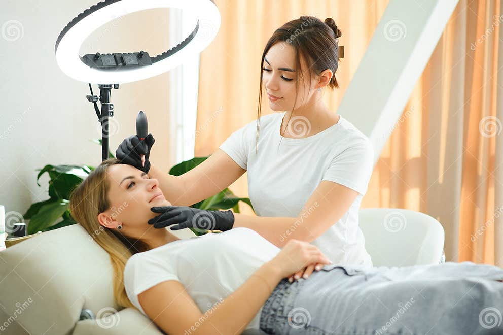 Process of Creating Permanent Brow Makeup with a Machine at Beauty ...