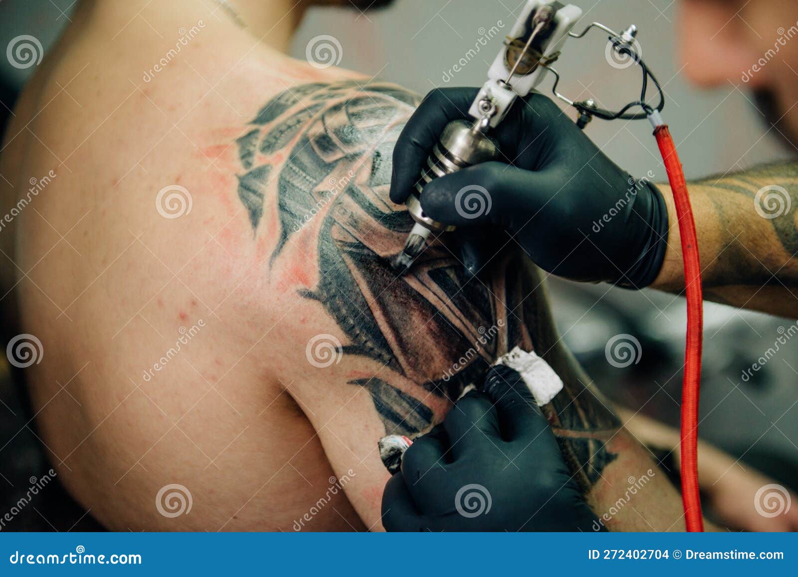 The Process of Creating a Tattoo on the Back of a Man Stock Photo - Image of gloves, feather ...