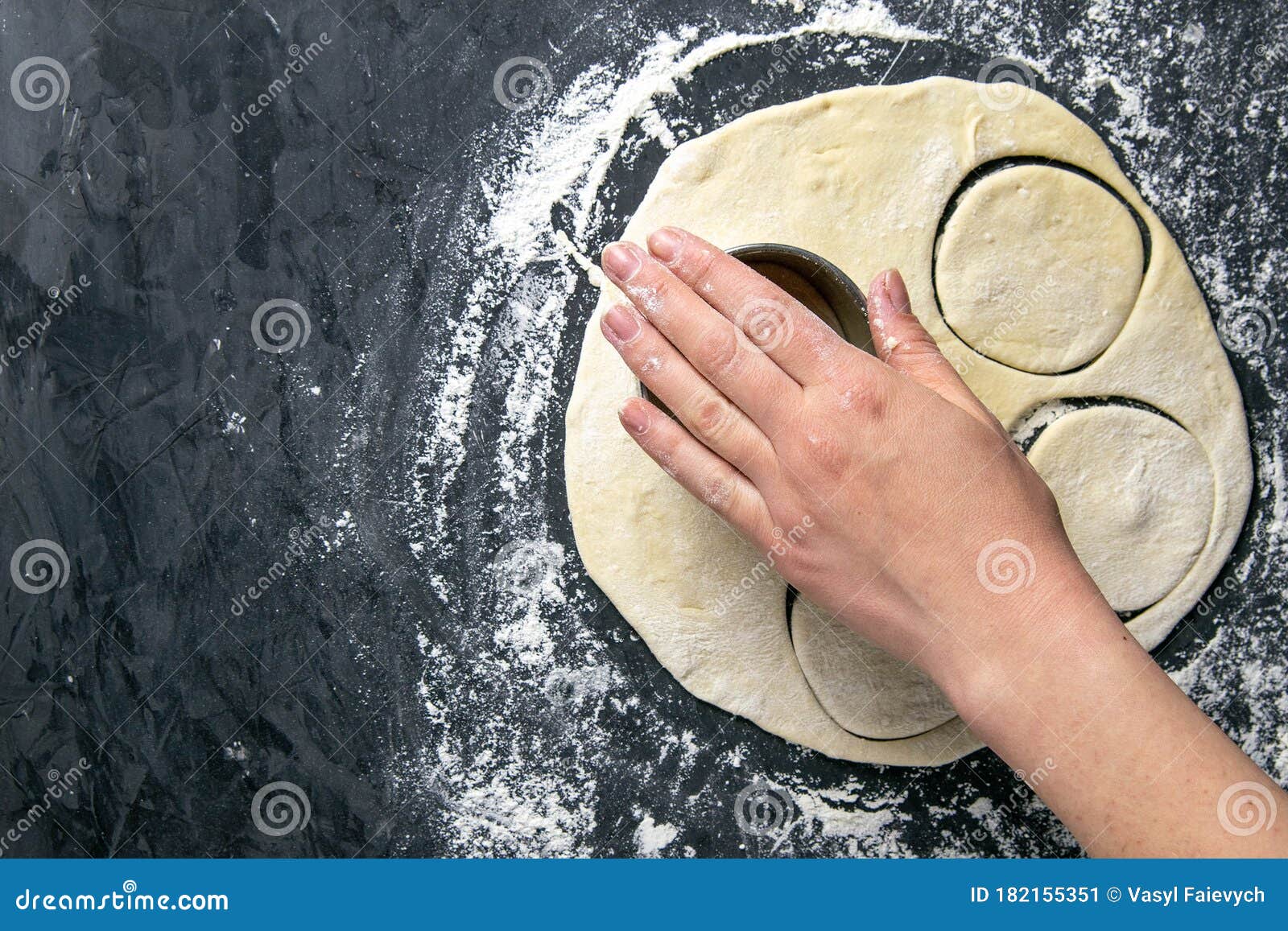 The Process of Cutting Circle from the Dough on a Dark Background. Top ...