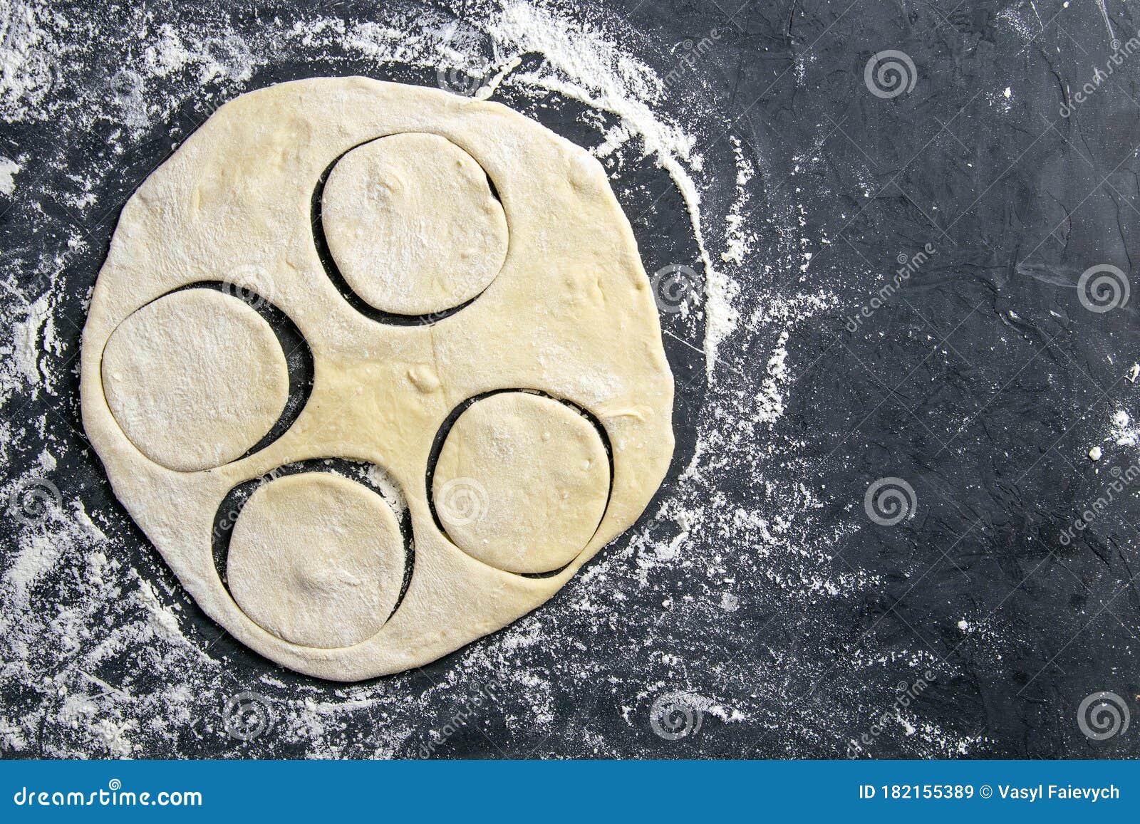 The Process of Cutting Circle from the Dough on a Dark Background. Top ...