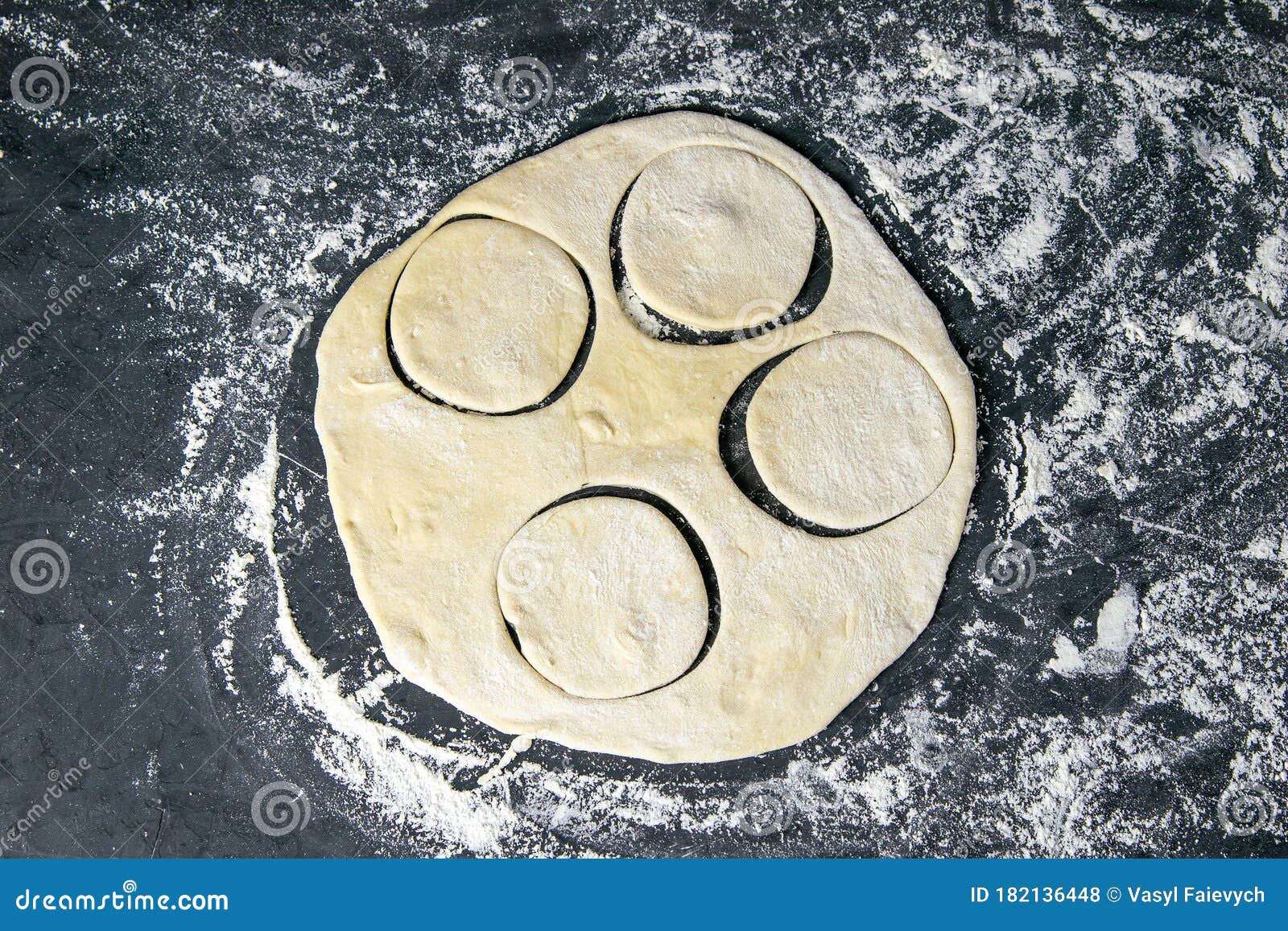 The Process of Cutting Circle from the Dough on a Dark Background. Top ...