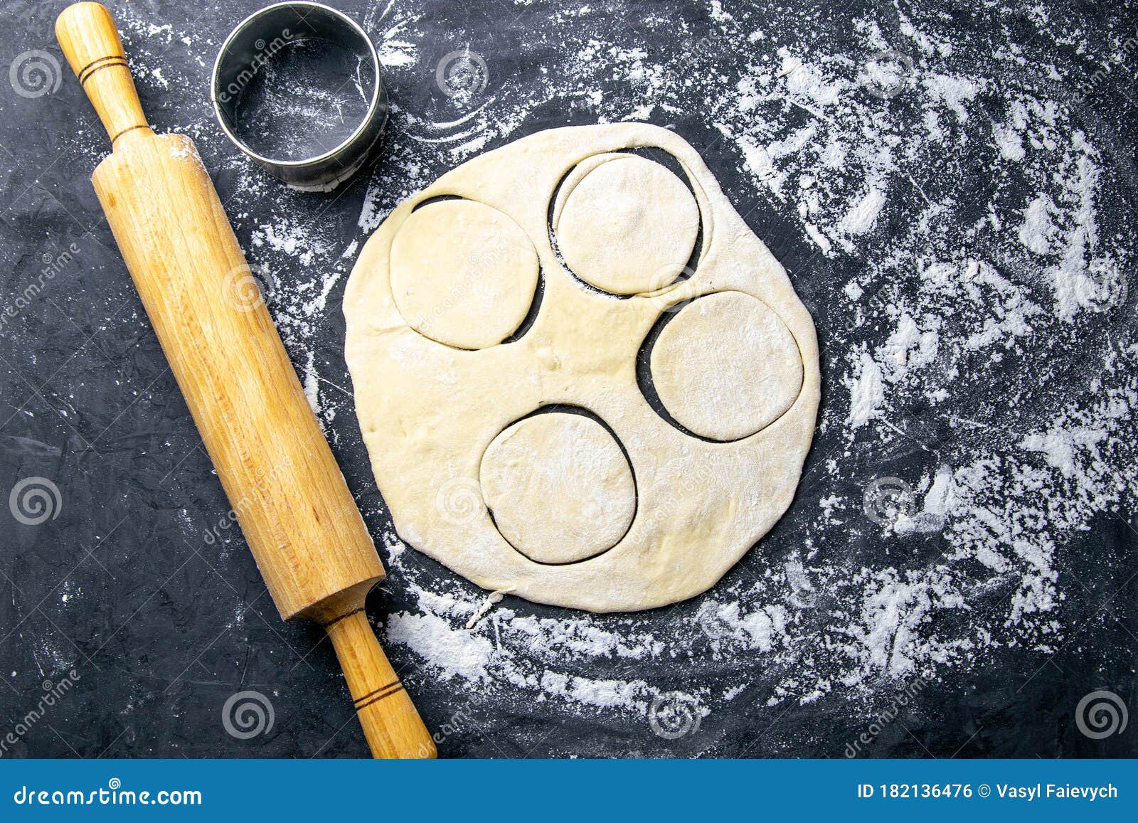 The Process of Cutting Circle from the Dough on a Dark Background. Top ...