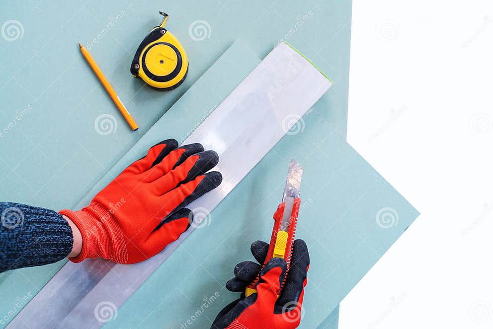 The Process of Cutting Drywall Using a Construction Knife and a Ruler. Components for the ...