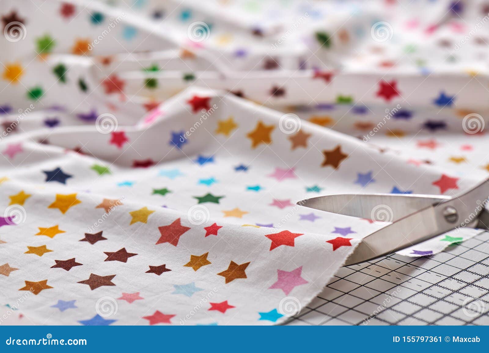 Process Cutting Fabric with a Pattern of Colorful Stars by Scissors on ...