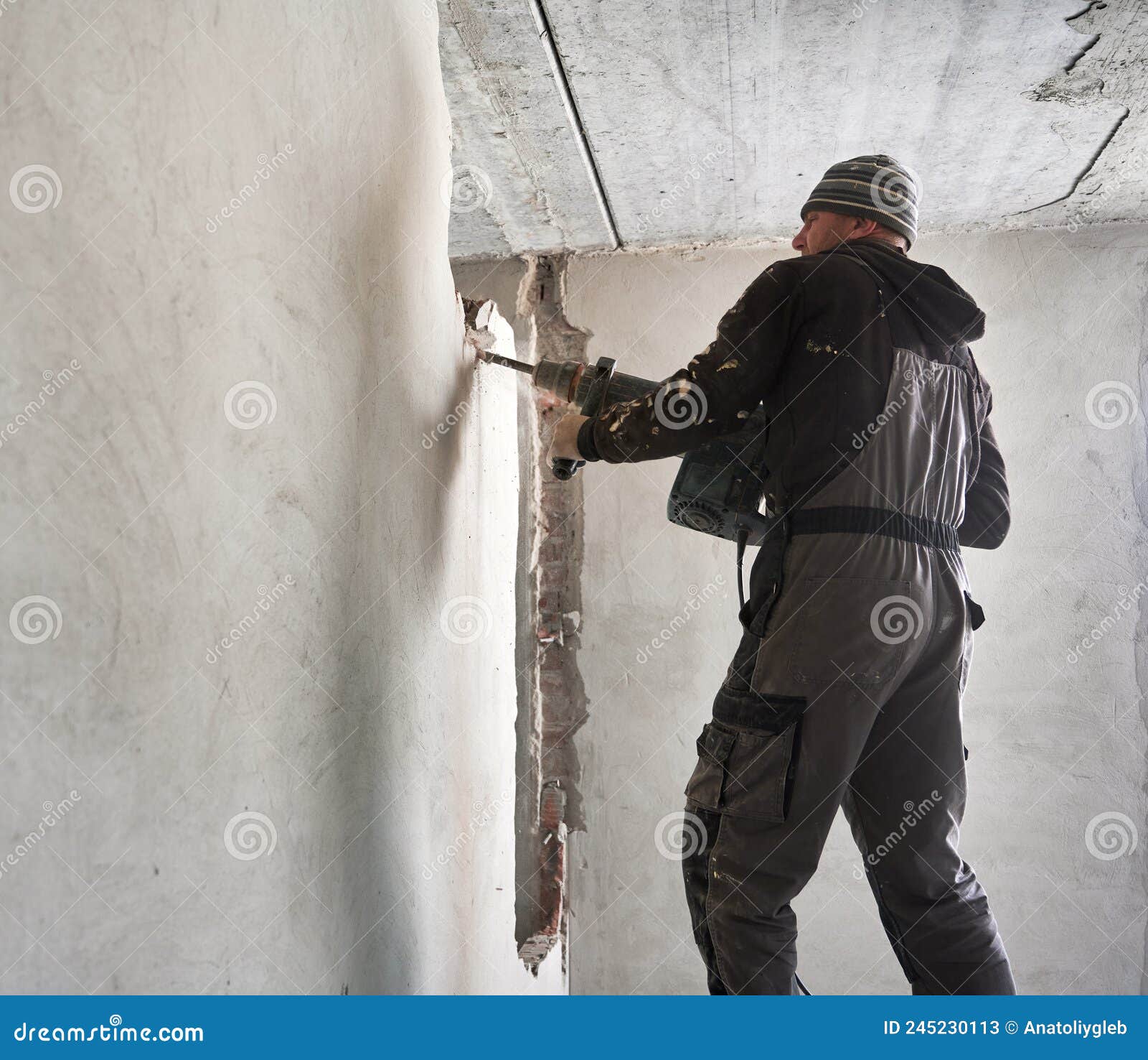 Worker Dismantling Interior Wall in Room Using Perforator. Stock Image ...