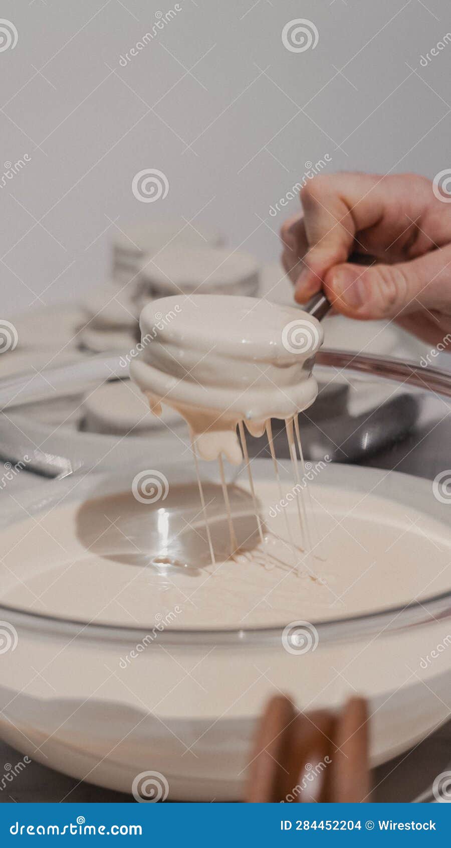 Process of Dipping a Cookie into a Bowl of Melted Chocolate Stock Photo ...