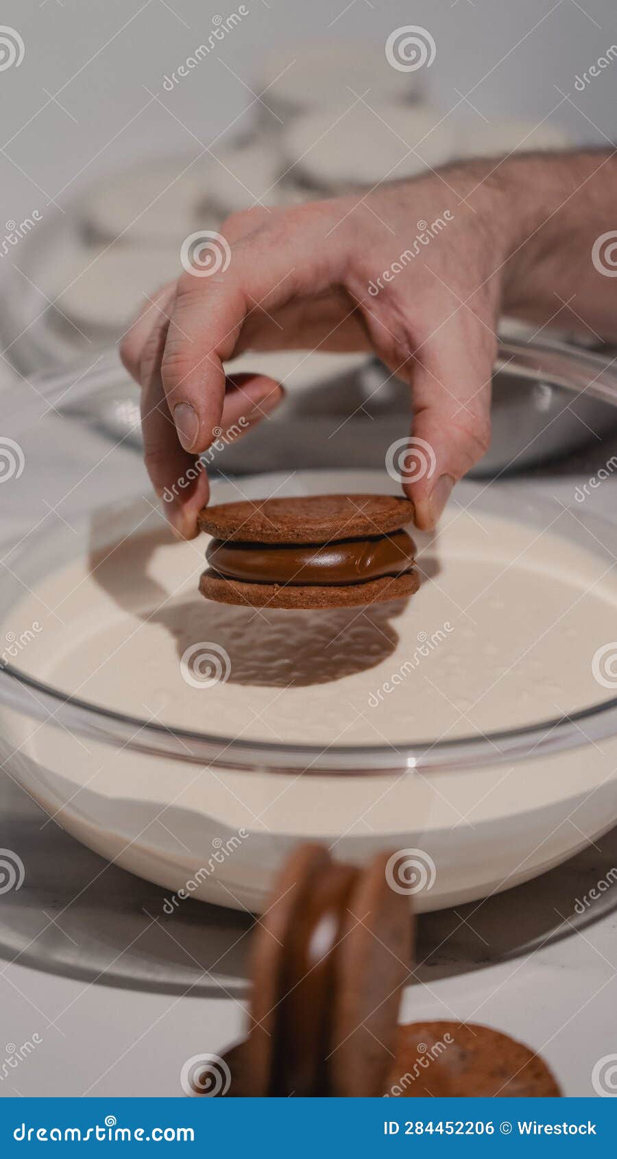 Process of Dipping a Cookie into a Bowl of Melted Chocolate Stock Photo ...