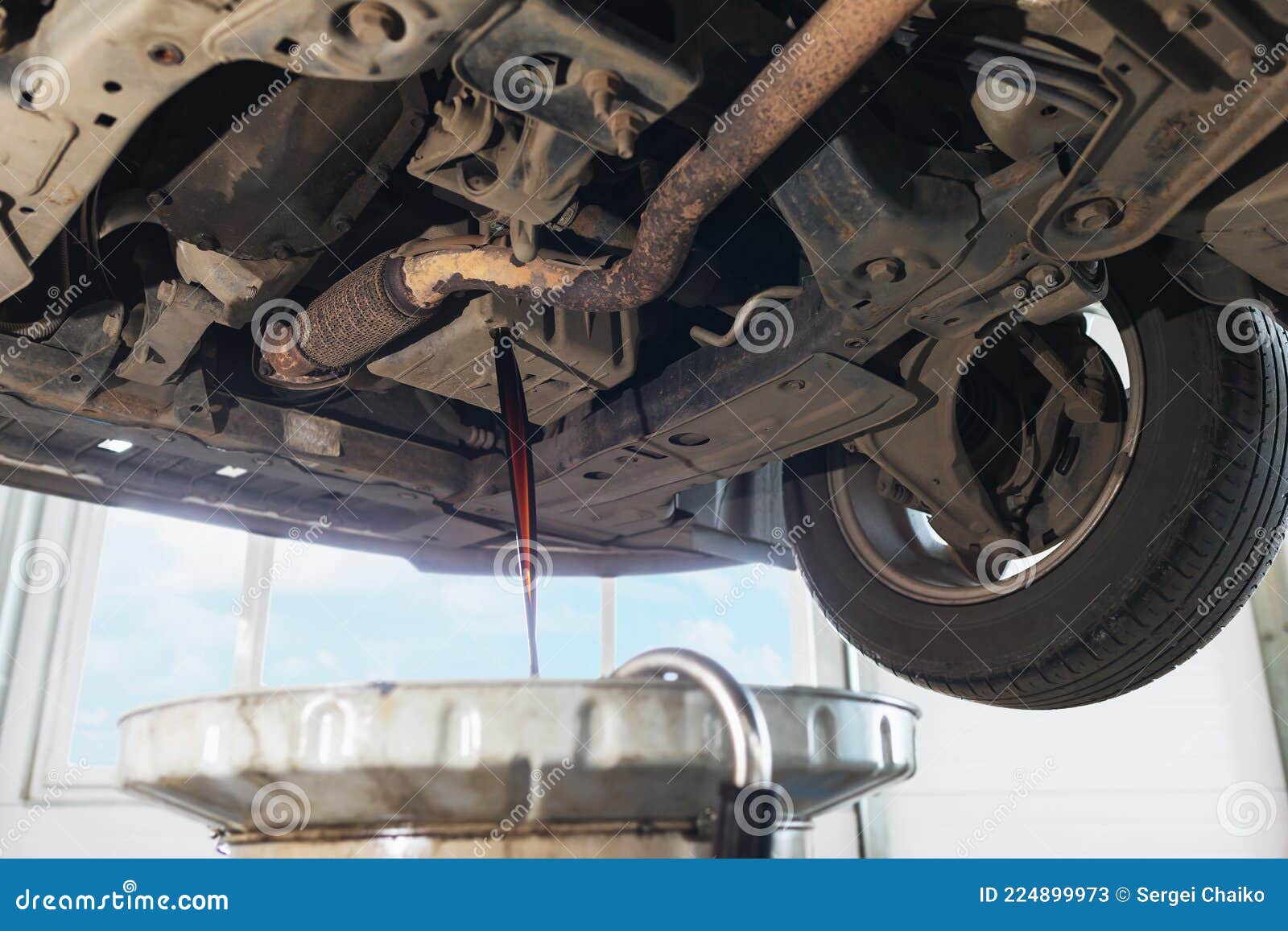 The Process of Draining Used Engine Oil from the Crankcase into the ...