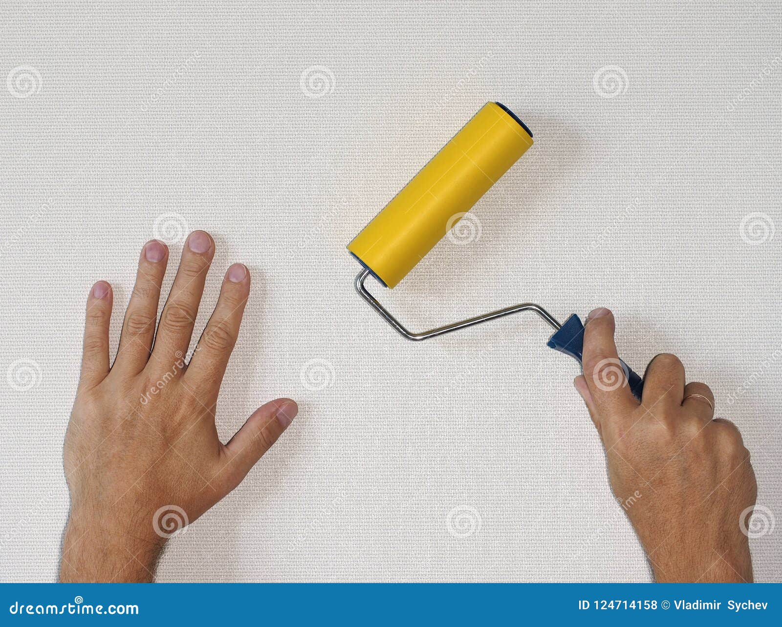 Process of Gluing of Wallpaper. Handwork by the Wallpaper Roller Stock ...