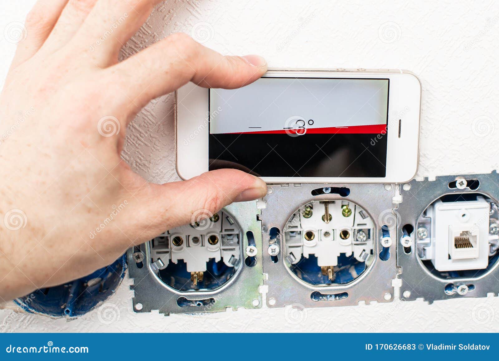 The Process of Installation Electrical Sockets Level with a Smartphone ...