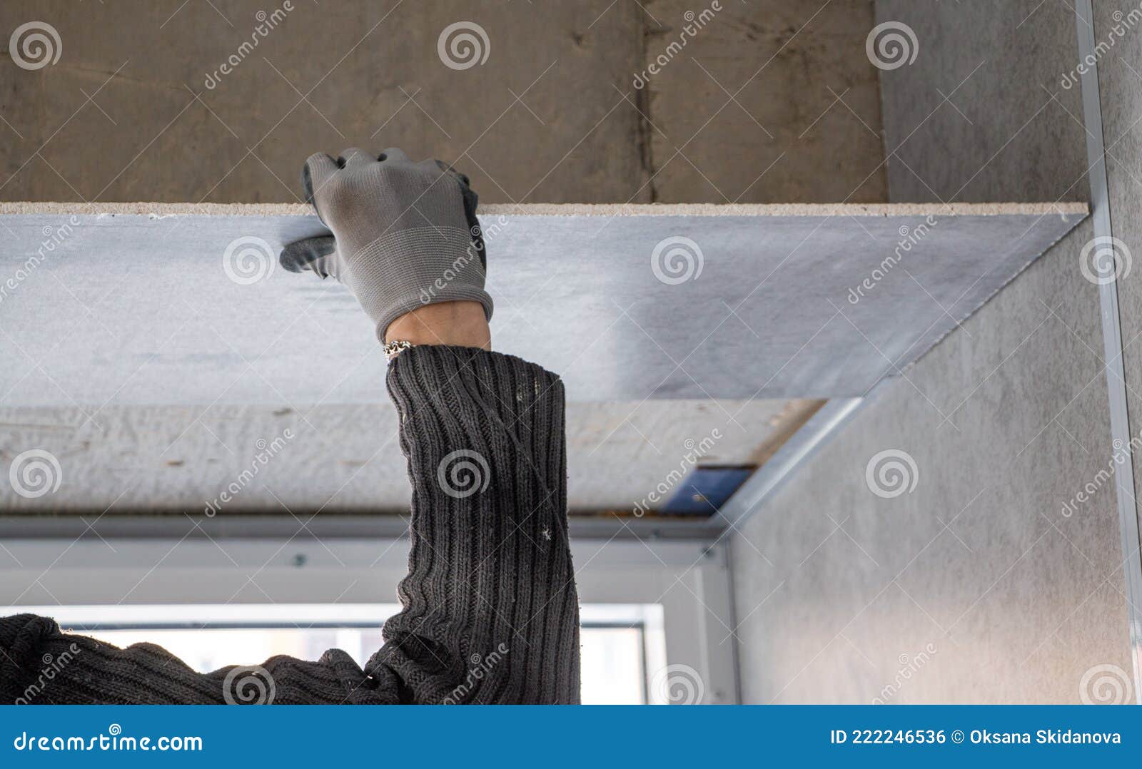 Process of Installing Drywall on Concrete Surfaces in Room with Hands ...