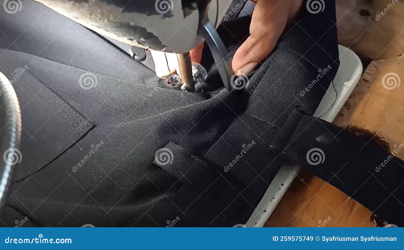 The Process of Installing Pants Buttons Using a Manual Machine Stock ...