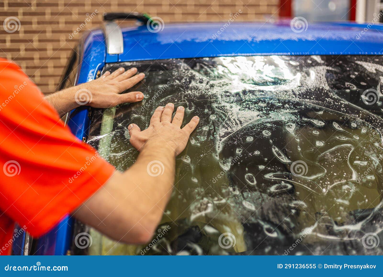 The Process of Installing the PPF on the Windshield of a Car. Stock ...