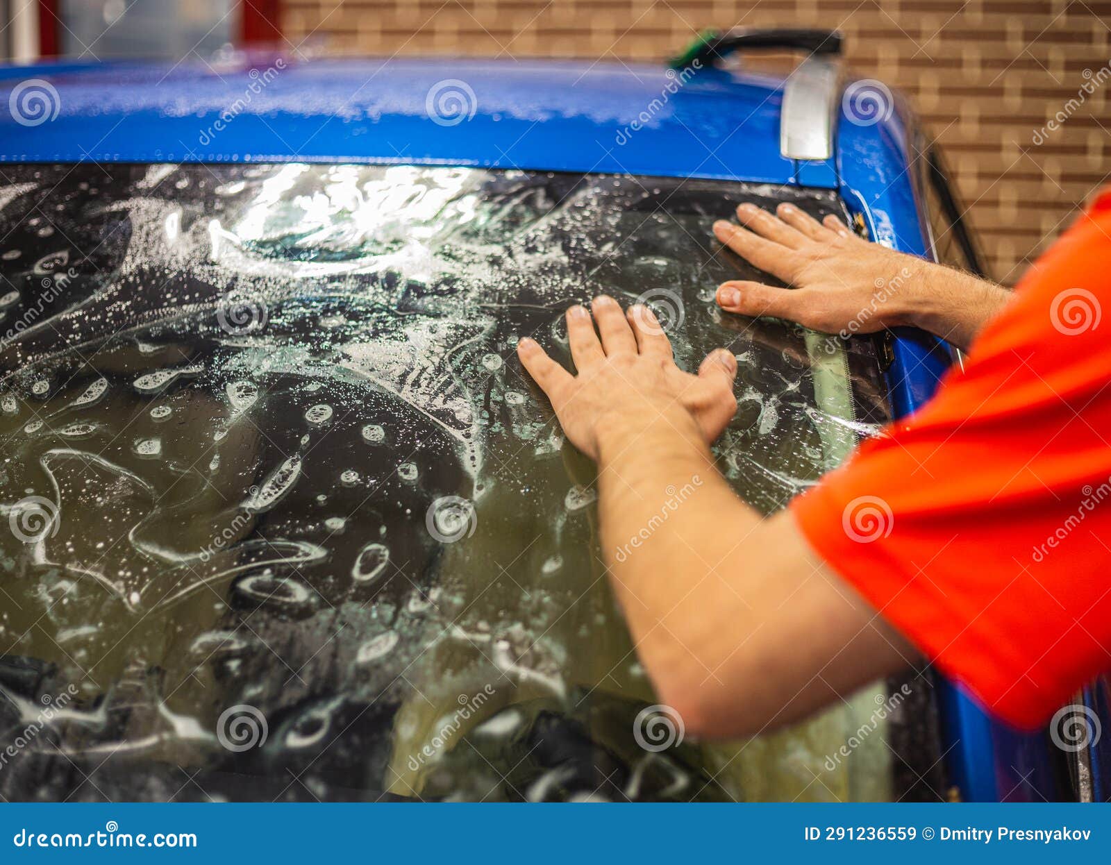 The Process of Installing the PPF on the Windshield of a Car. Stock ...