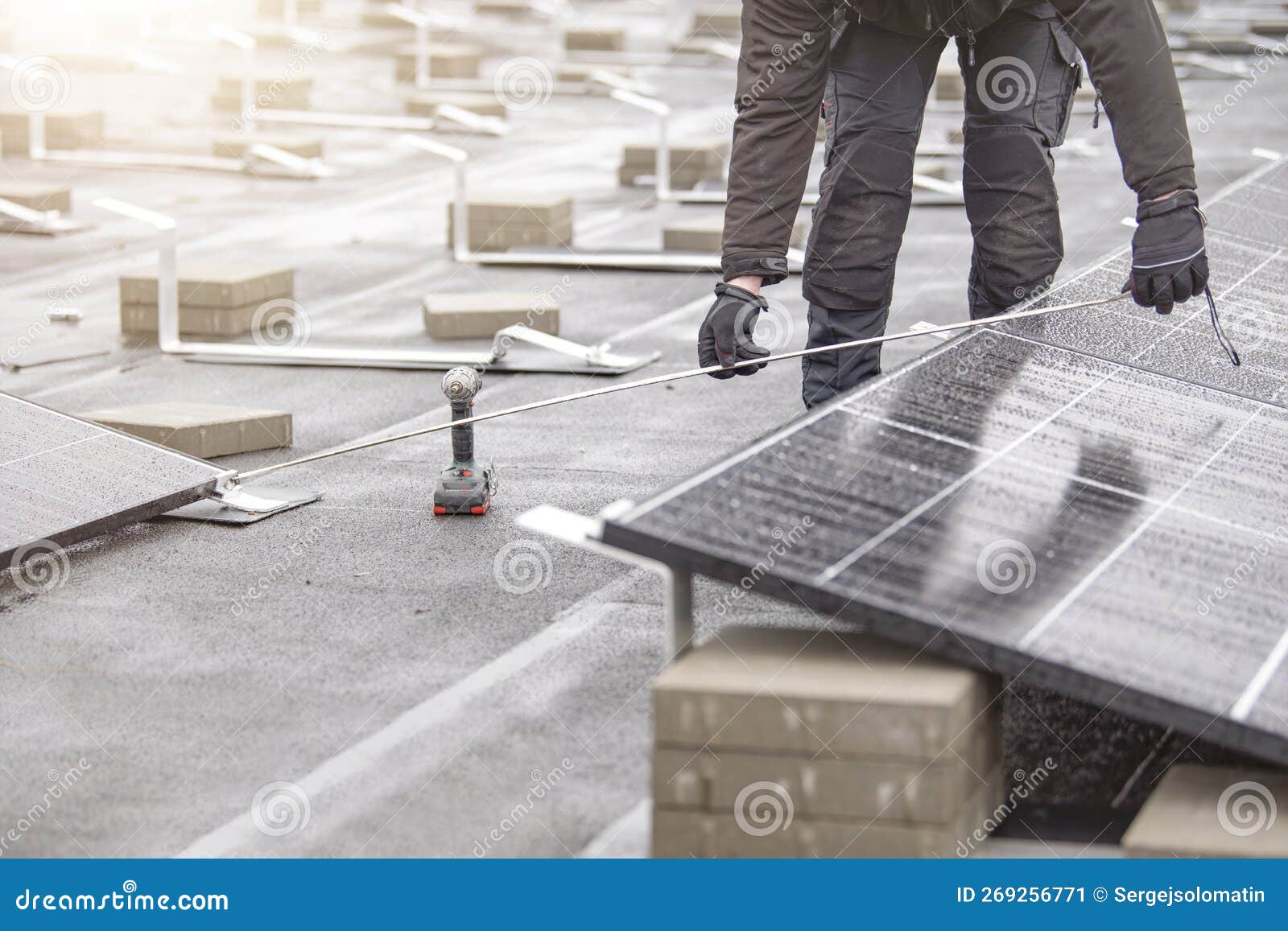 The Process of Installing Solar Panels. the Installer Measures the ...