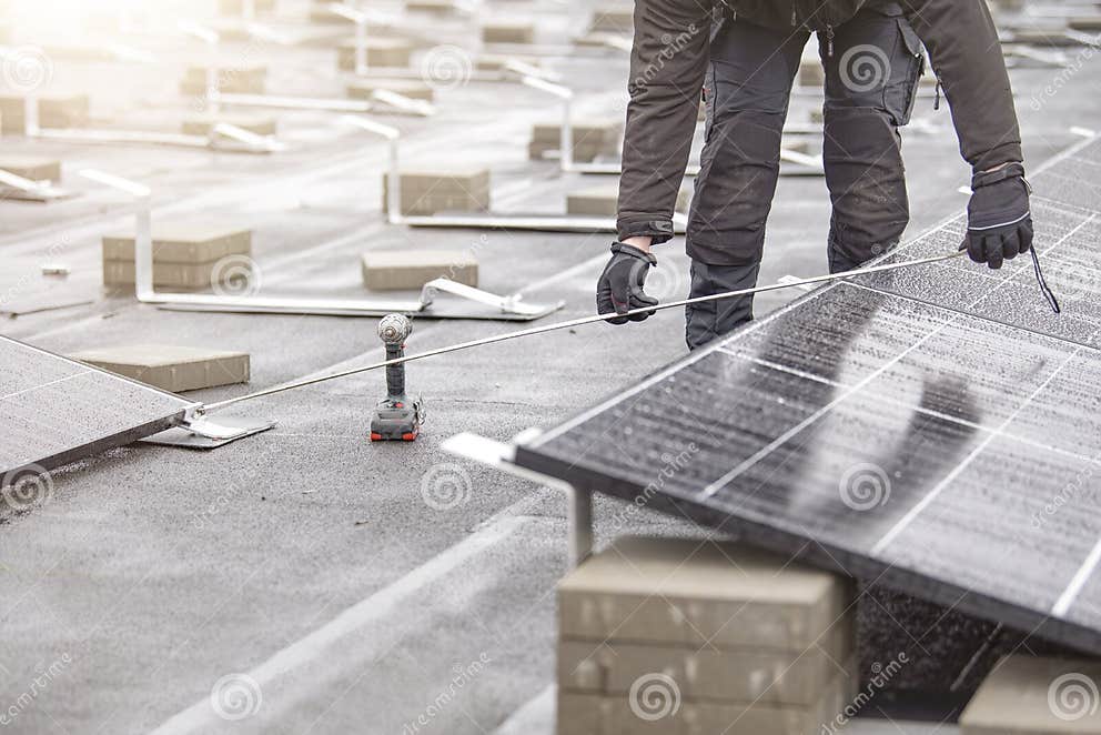 The Process of Installing Solar Panels. the Installer Measures the ...
