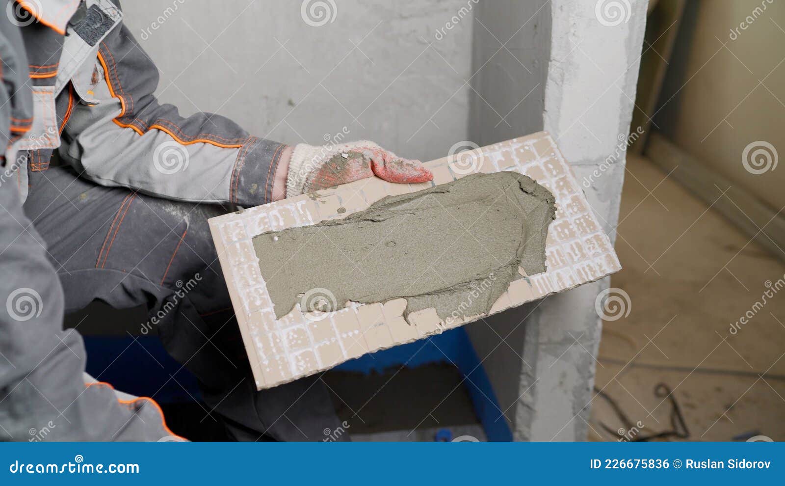 The Process of Laying Ceramic Floor Tiles with a Herringbone Pattern ...