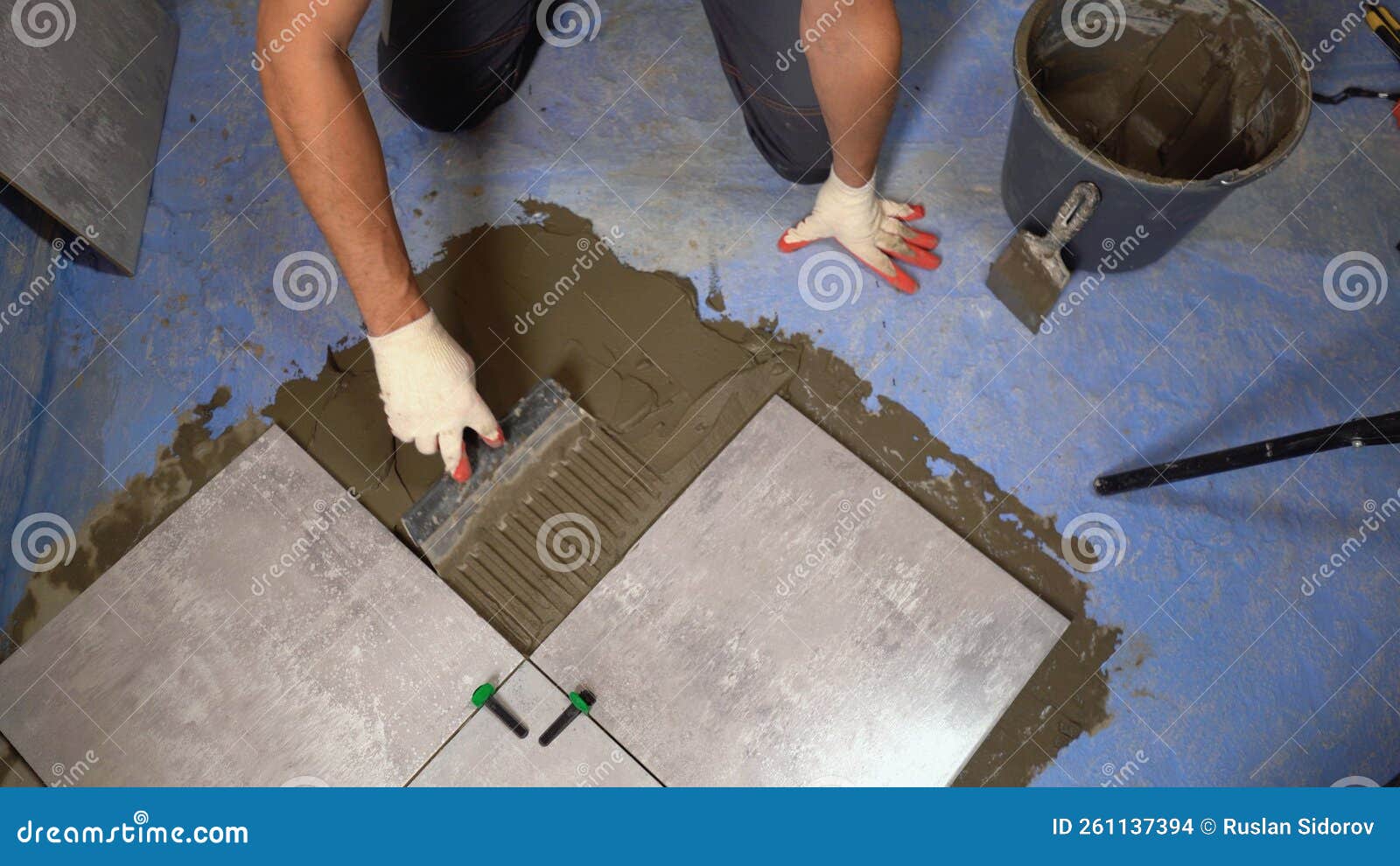 Renovation Man Construction Worker Laying Floor Tile Process Of Laying Floor Ceramic Tiles