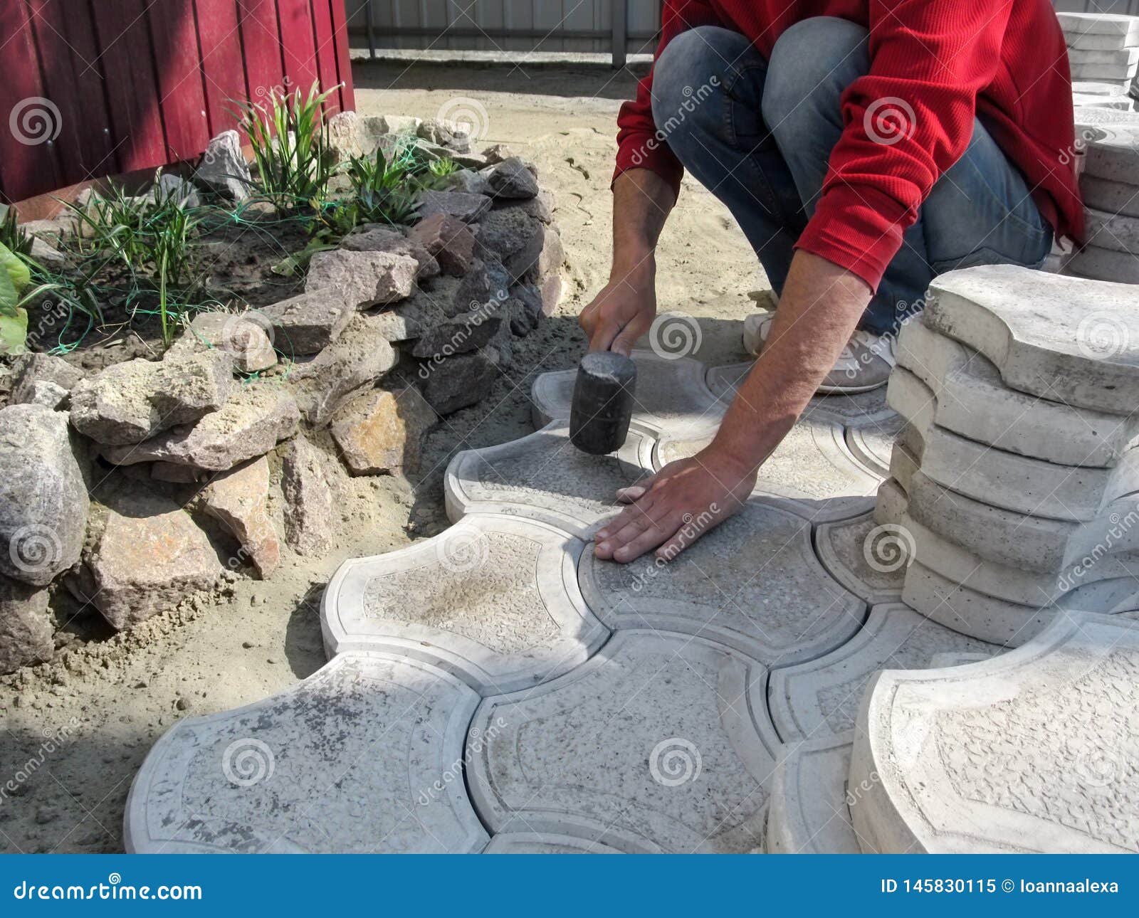 The Process of Laying Paving Slabs in the Courtyard with Flower Bed ...