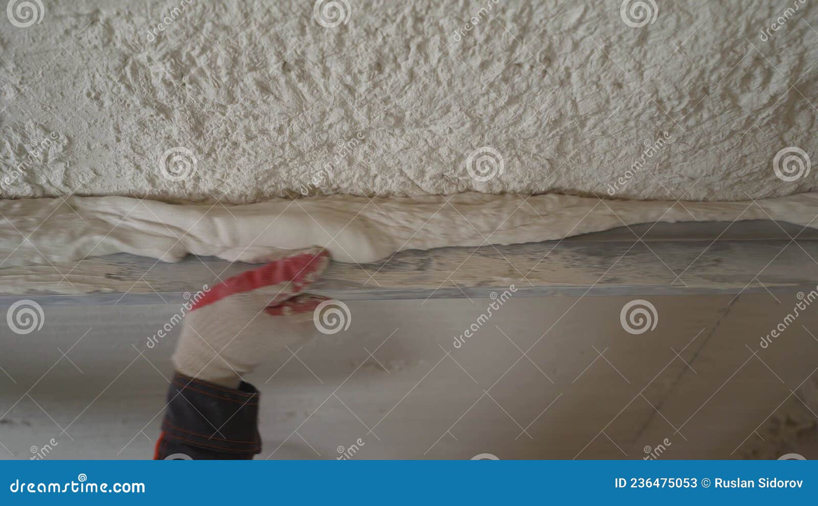 The Process of Leveling Plaster on a Wall Using a Tool. the Worker ...