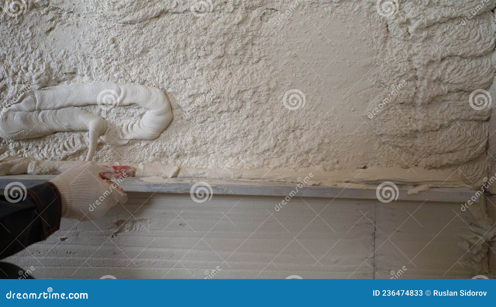 The Process of Leveling Plaster on a Wall Using a Tool. the Worker ...
