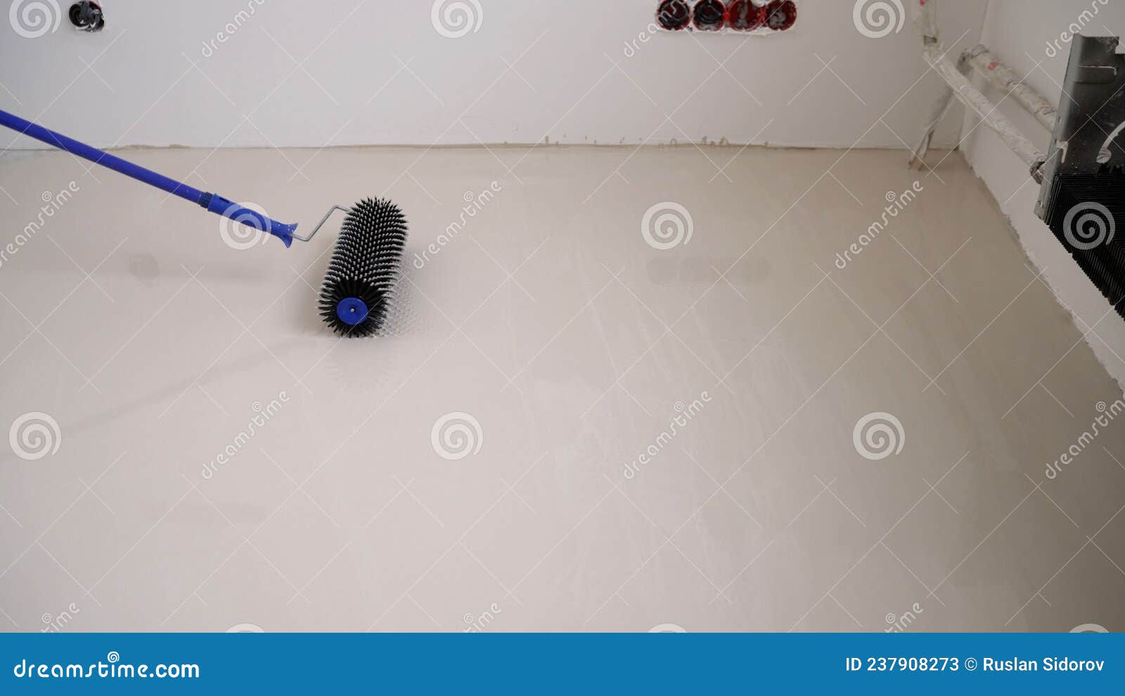 The Process of Leveling the Self-leveling Floor. Worker Applying Epoxy ...