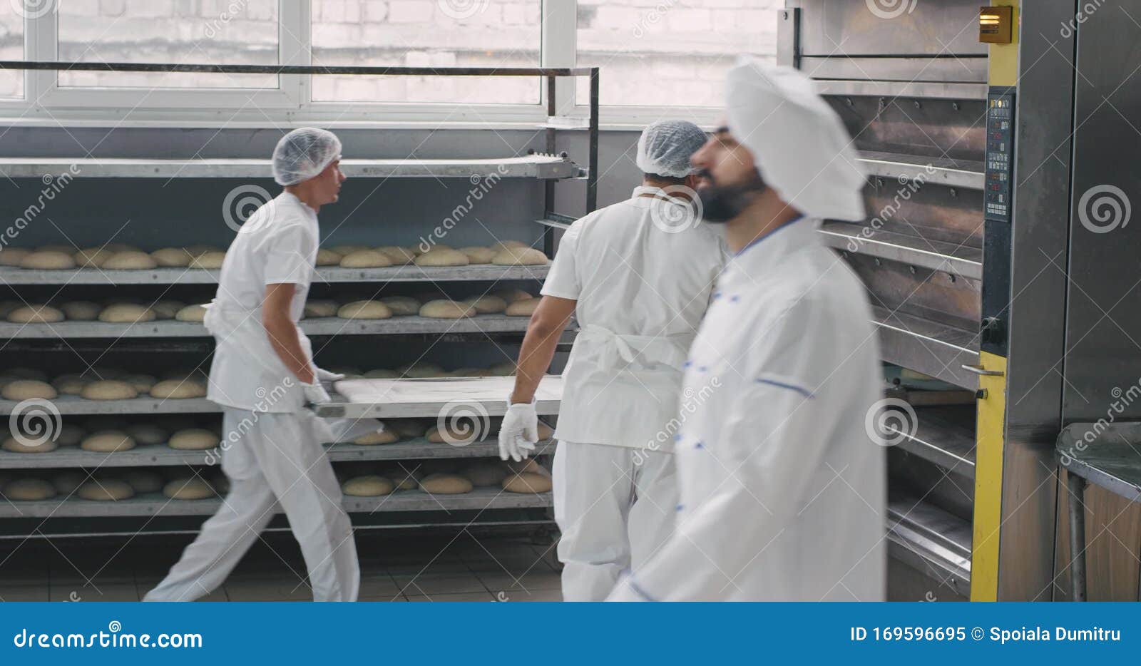 Process of Load the Raw Bread in the Oven Machine of Two Bakery Workers ...