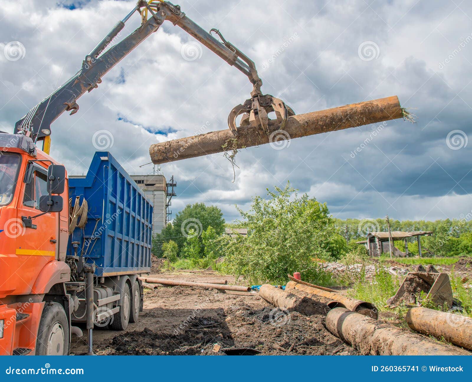 Special Loader with Help of Grab Grabbed Old Cast-iron Pipe and Loads ...