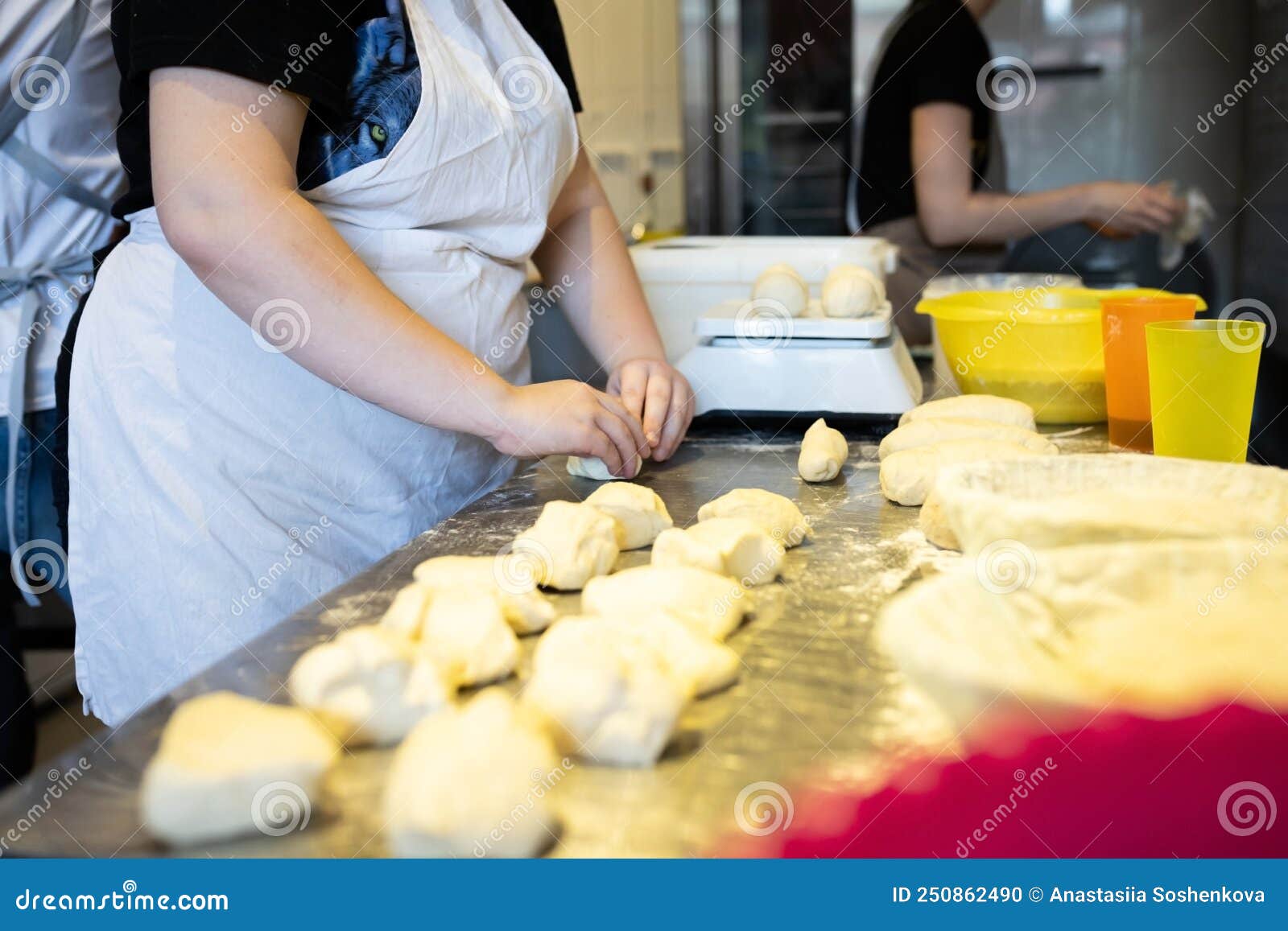 The Process of Making Bread. Dividing the Wheat Dough into Pieces for ...