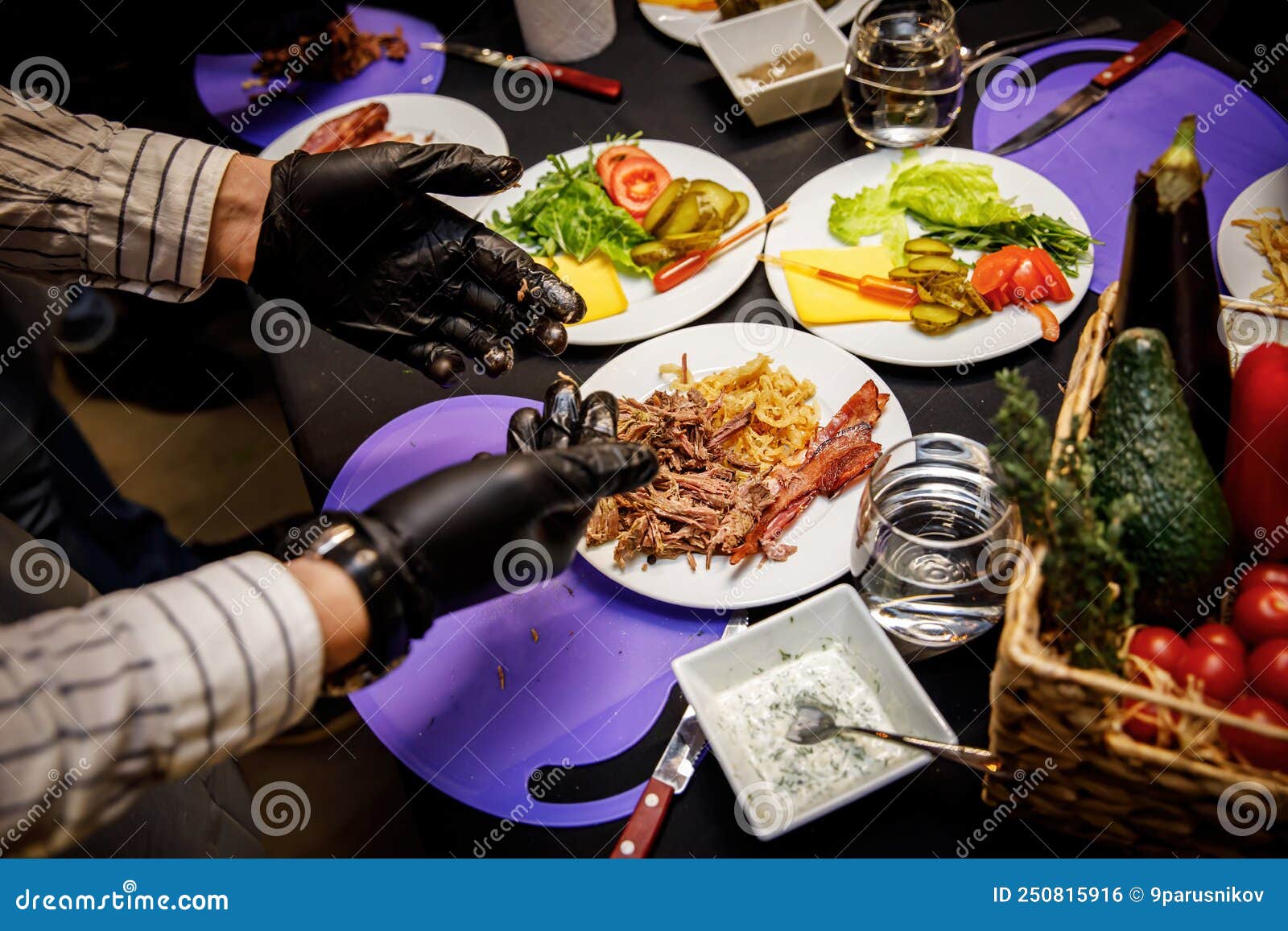 The Process of Making a Burger in a Restaurant Kitchen. Chef in Black ...