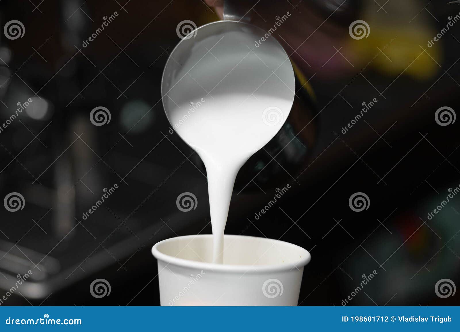 Hot, Frothed Milk is Poured from the Pitcher into a Paper Cup Stock ...