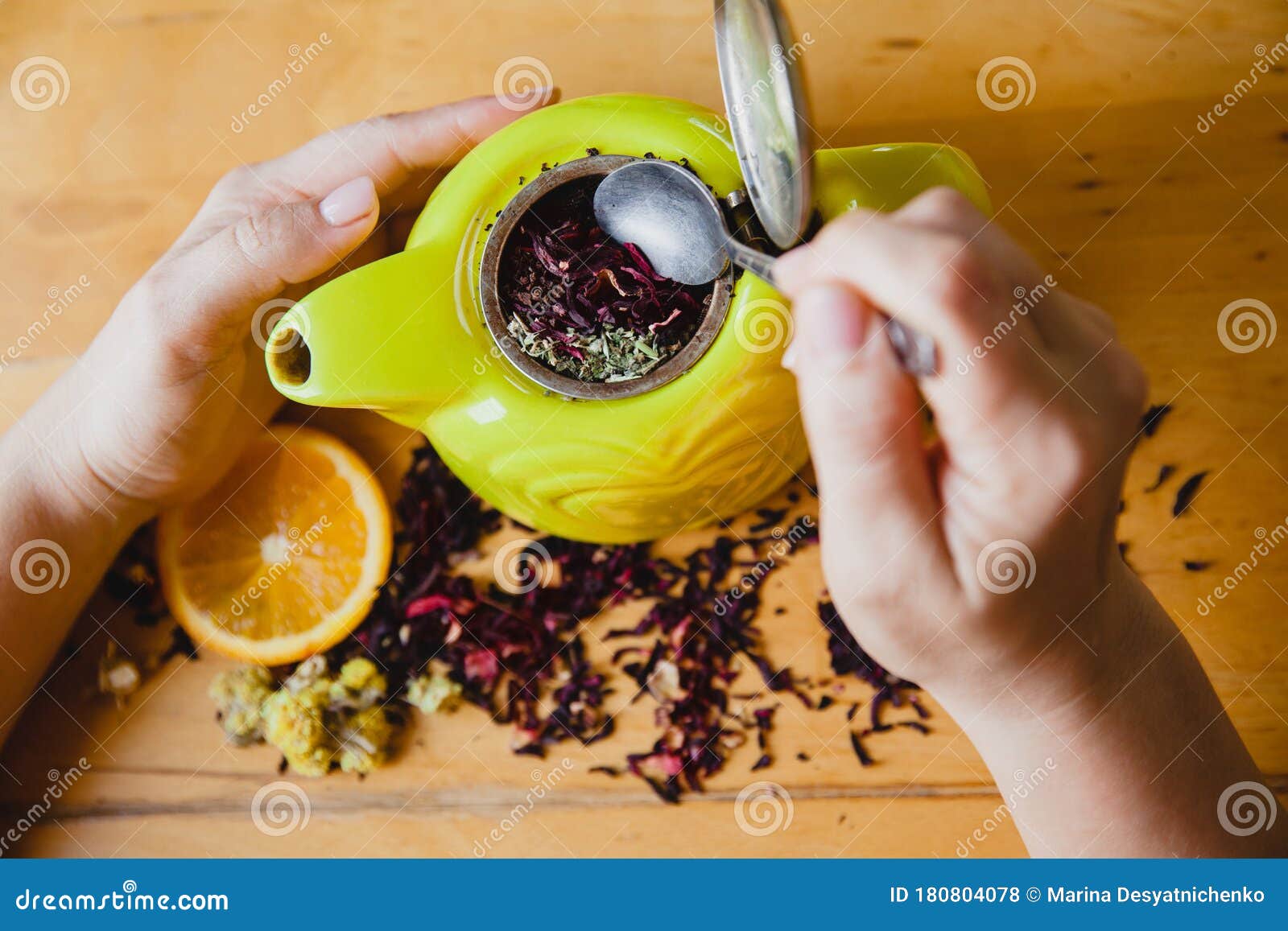 The Process of Making Herbal Tea in a Green Teapot on a Wooden Table ...
